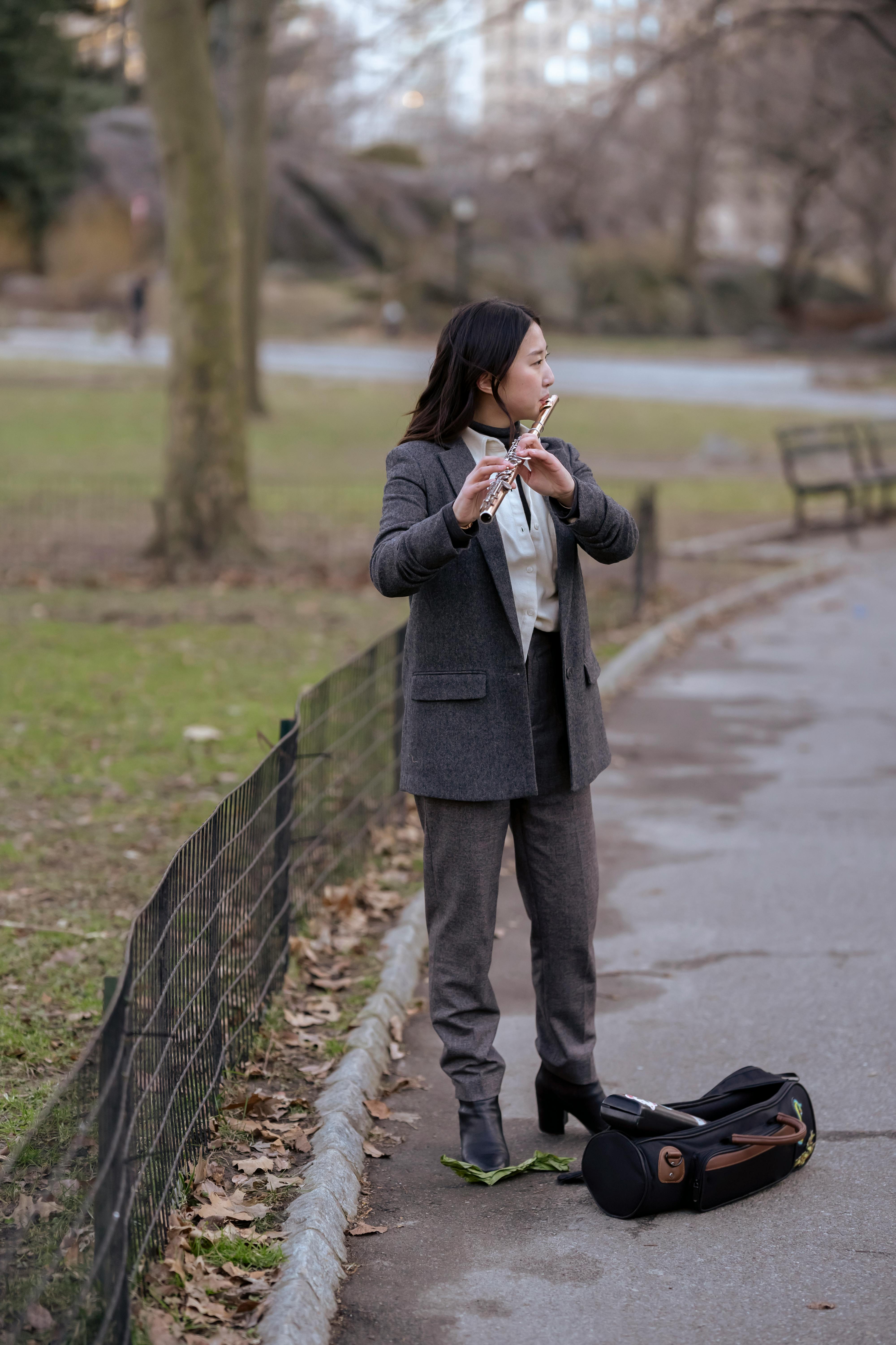 Pretty Woman Playing a Wind Instrument · Free Stock Photo