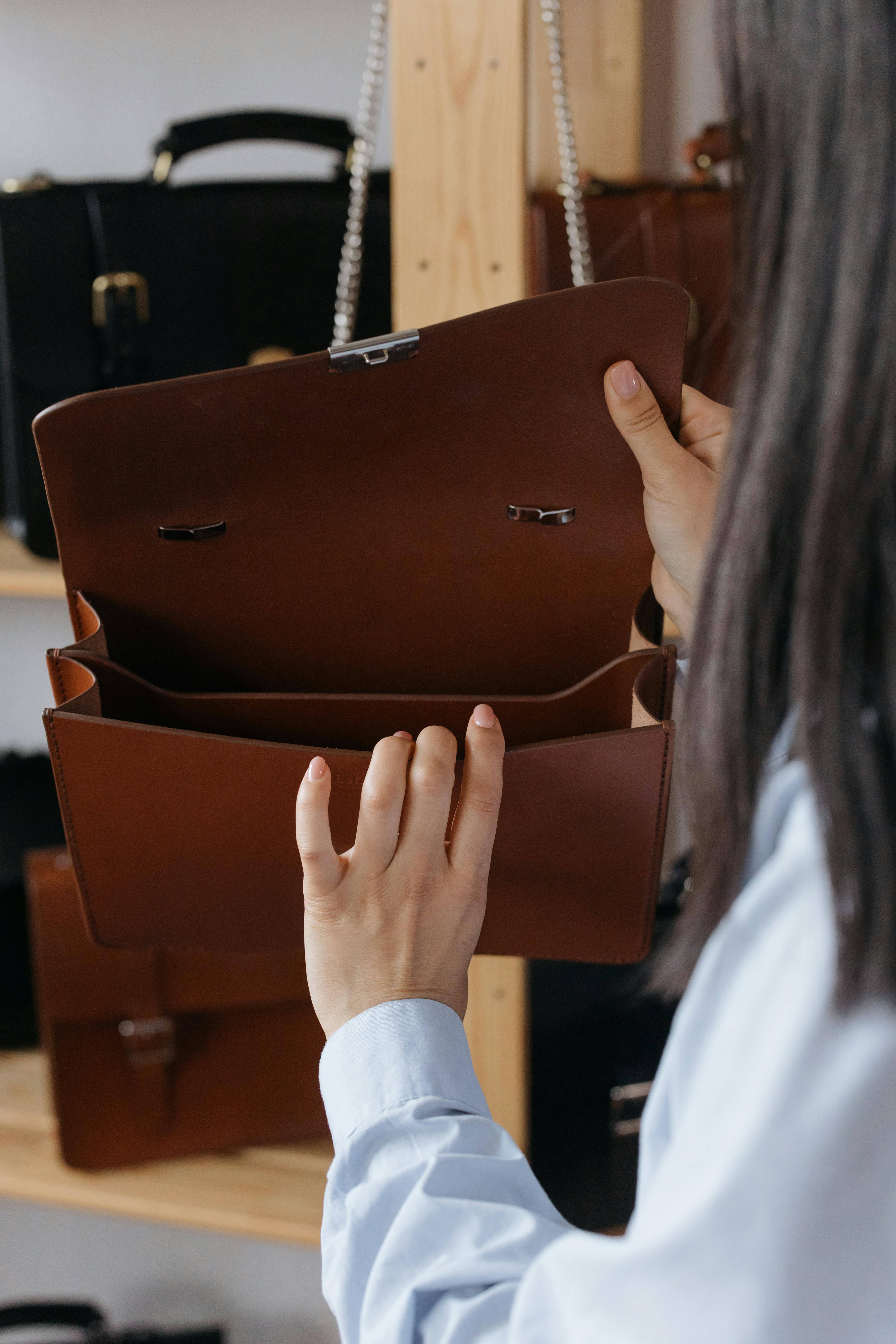 A Person Holding a Leather Shoulder Bag · Free Stock Photo