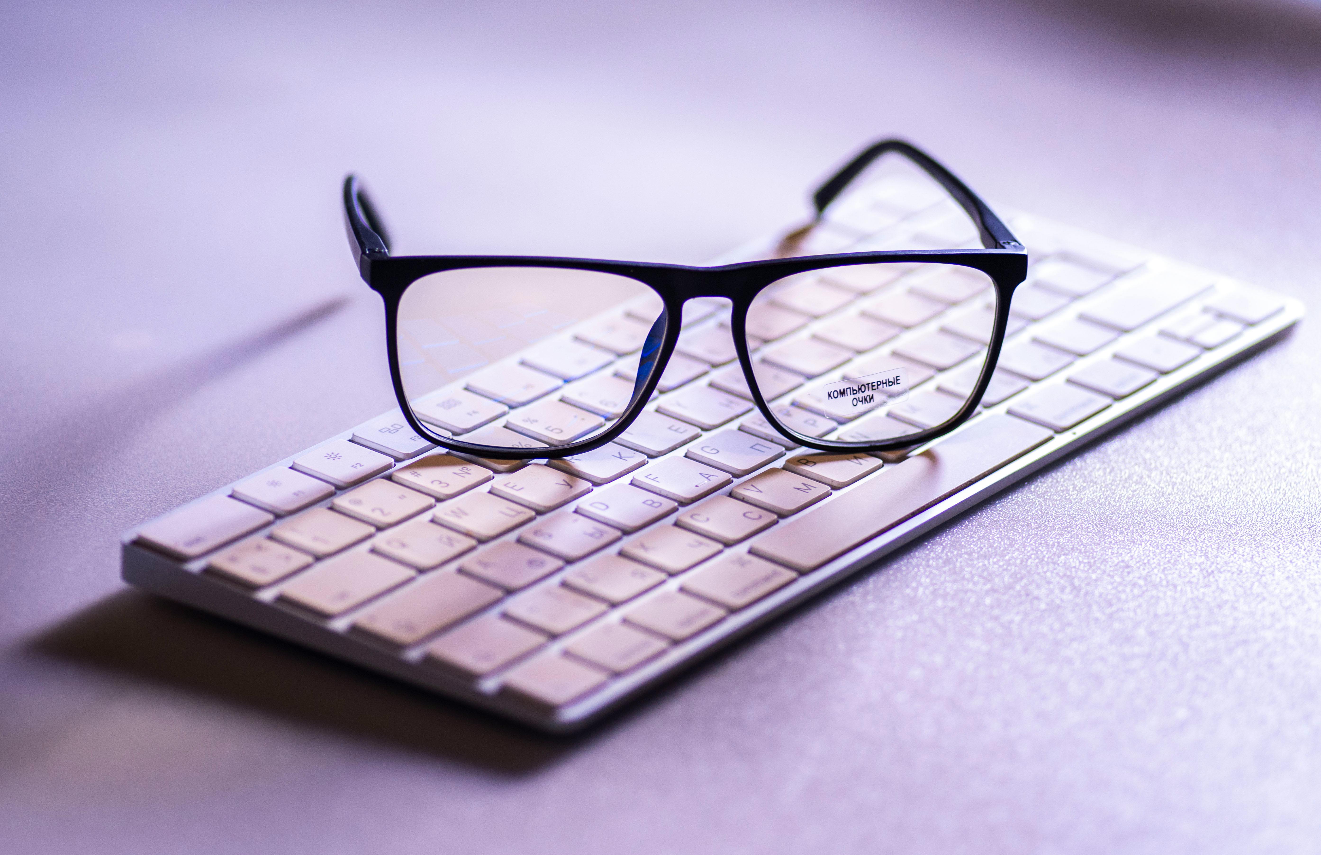 Canon Camera Lens Covers Beside Screwdriver and Computer Keyboard ...