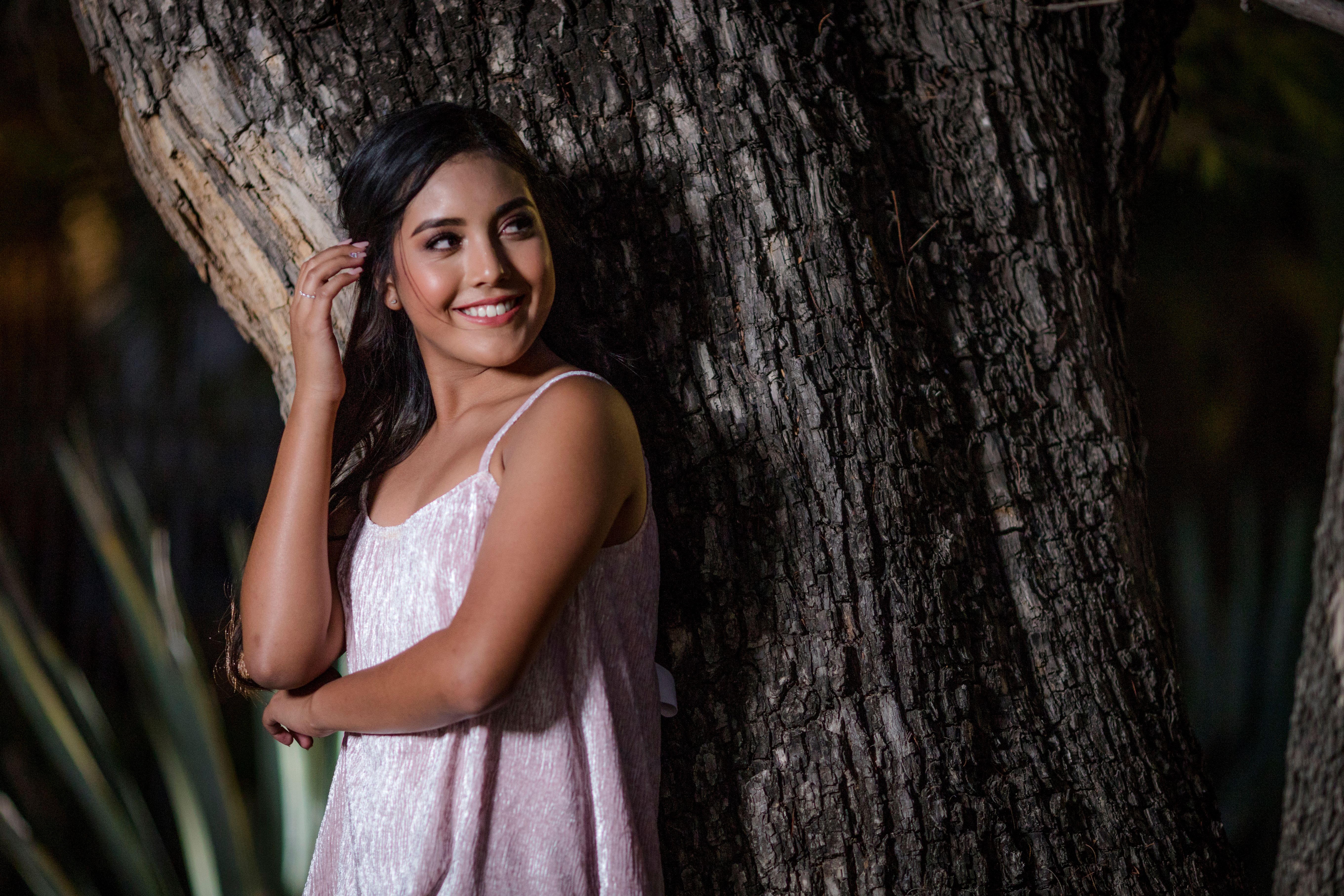 Woman Posing Near a Tree Trunk · Free Stock Photo