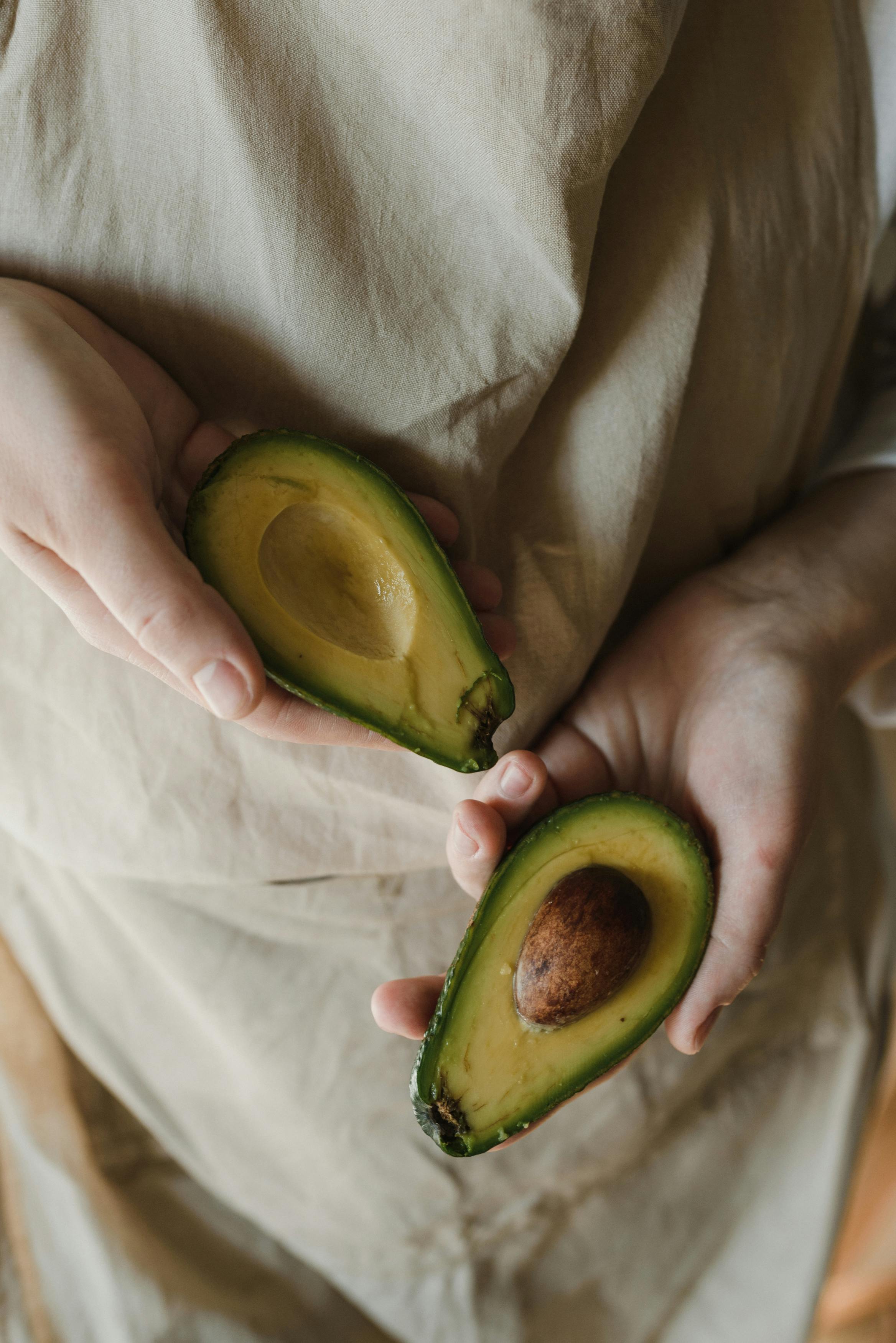 A Person Holding Slices of Avocado · Free Stock Photo