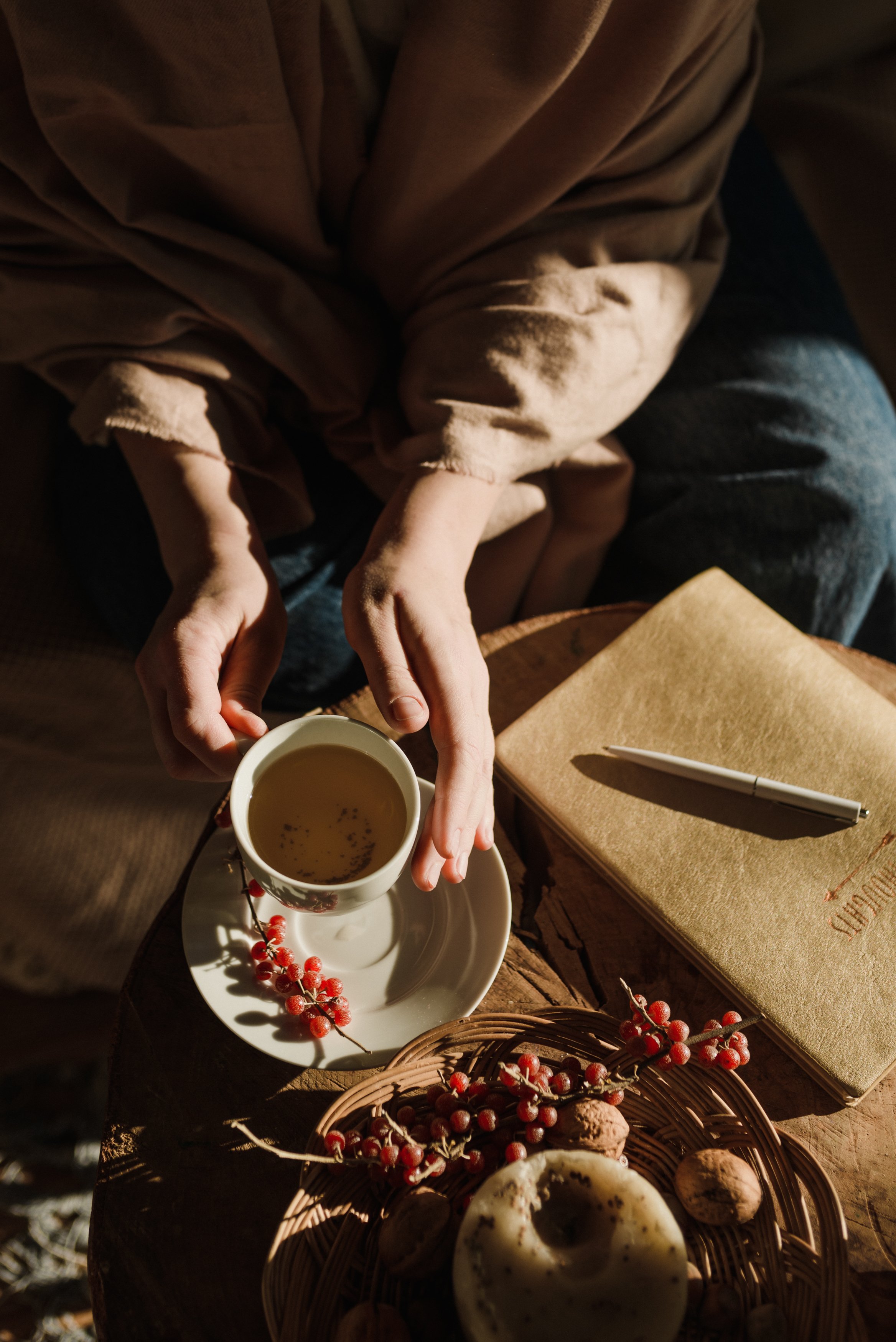 A Person Holding a Cup of Tea on a Saucer · Free Stock Photo