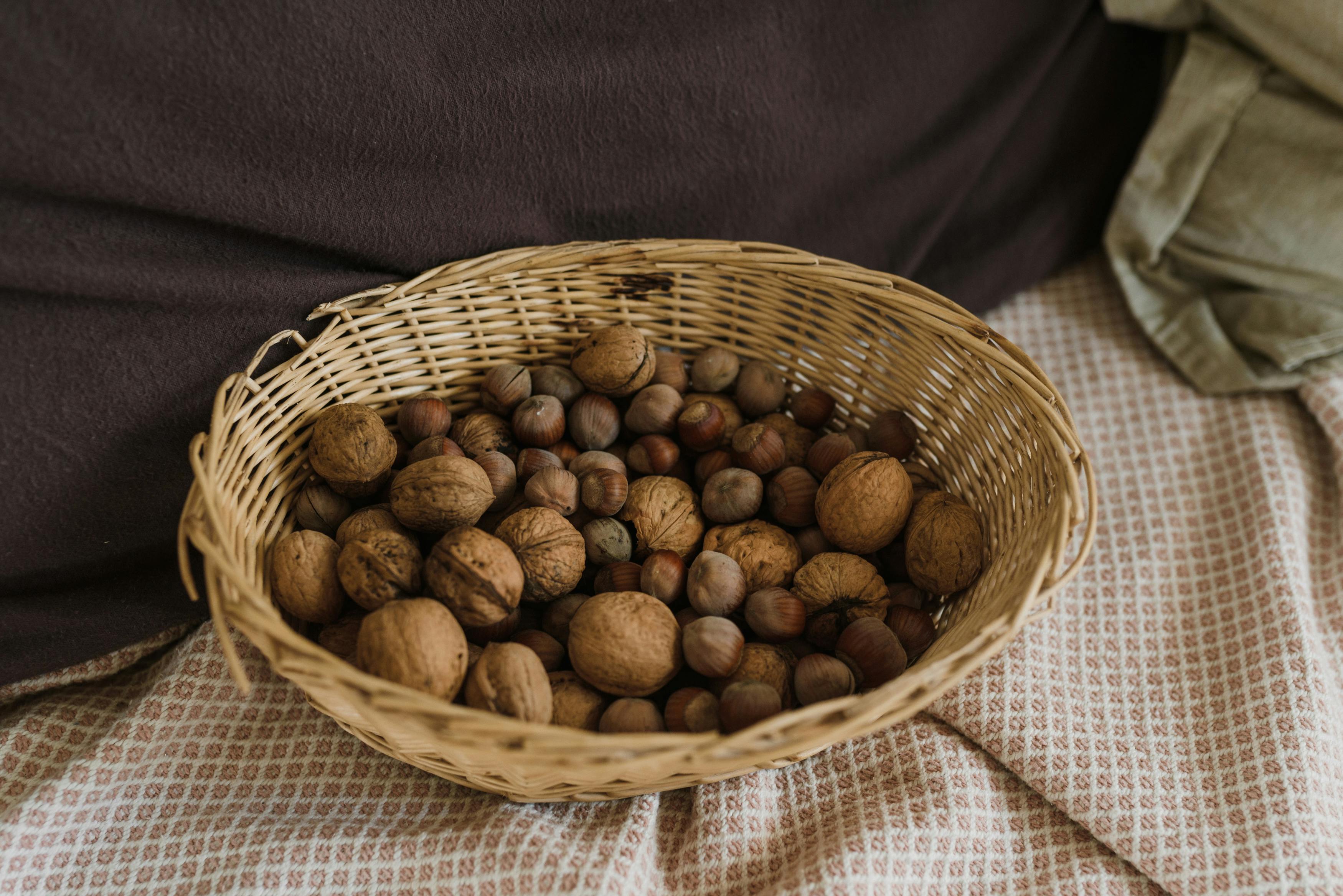 Assorted Nuts with Shells in a Wicker Basket · Free Stock Photo