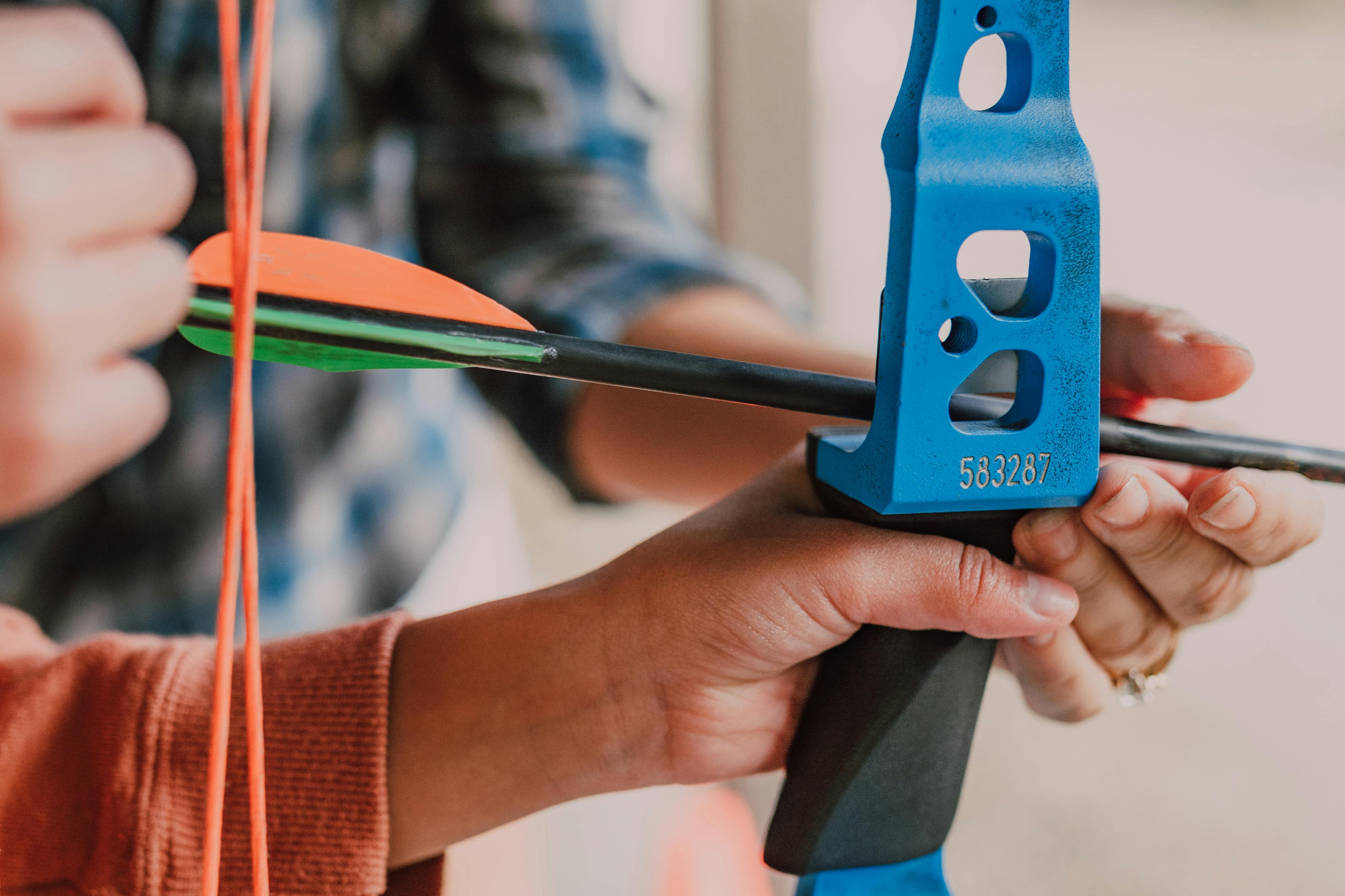 Person Holding a Bow and Arrow · Free Stock Photo