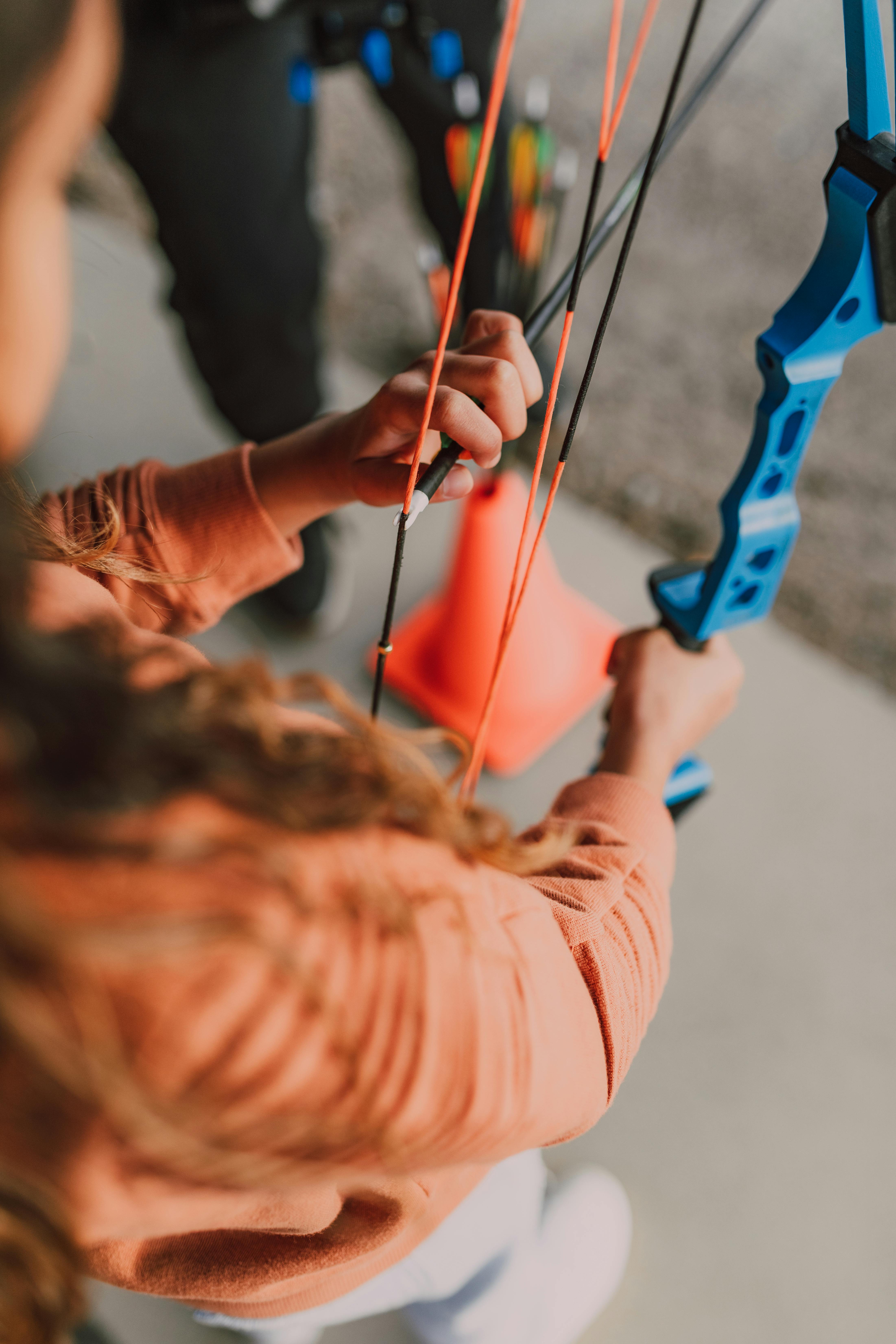 A Person Using a Compound Bow · Free Stock Photo