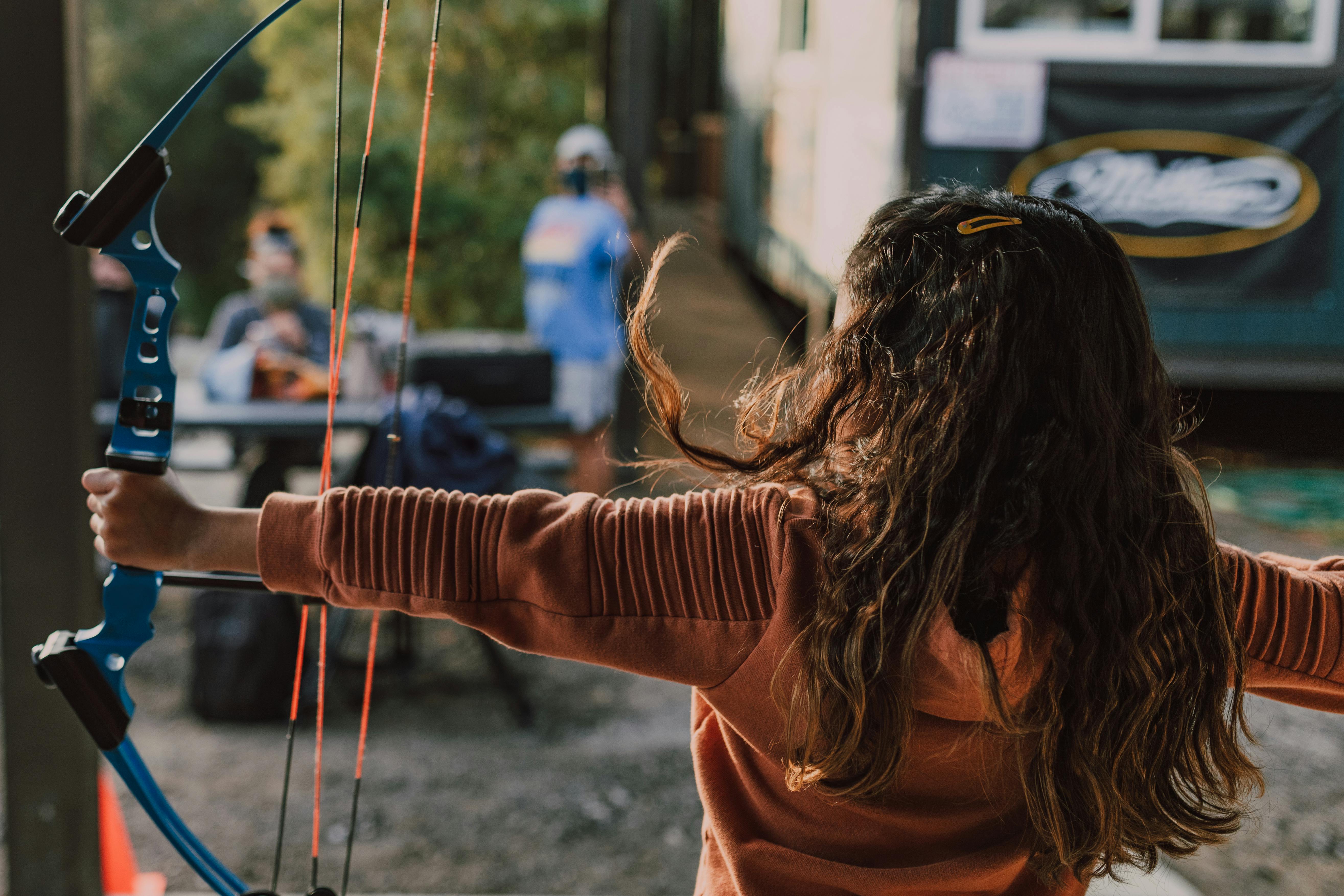 Two Girls Holding an Archery Bow · Free Stock Photo