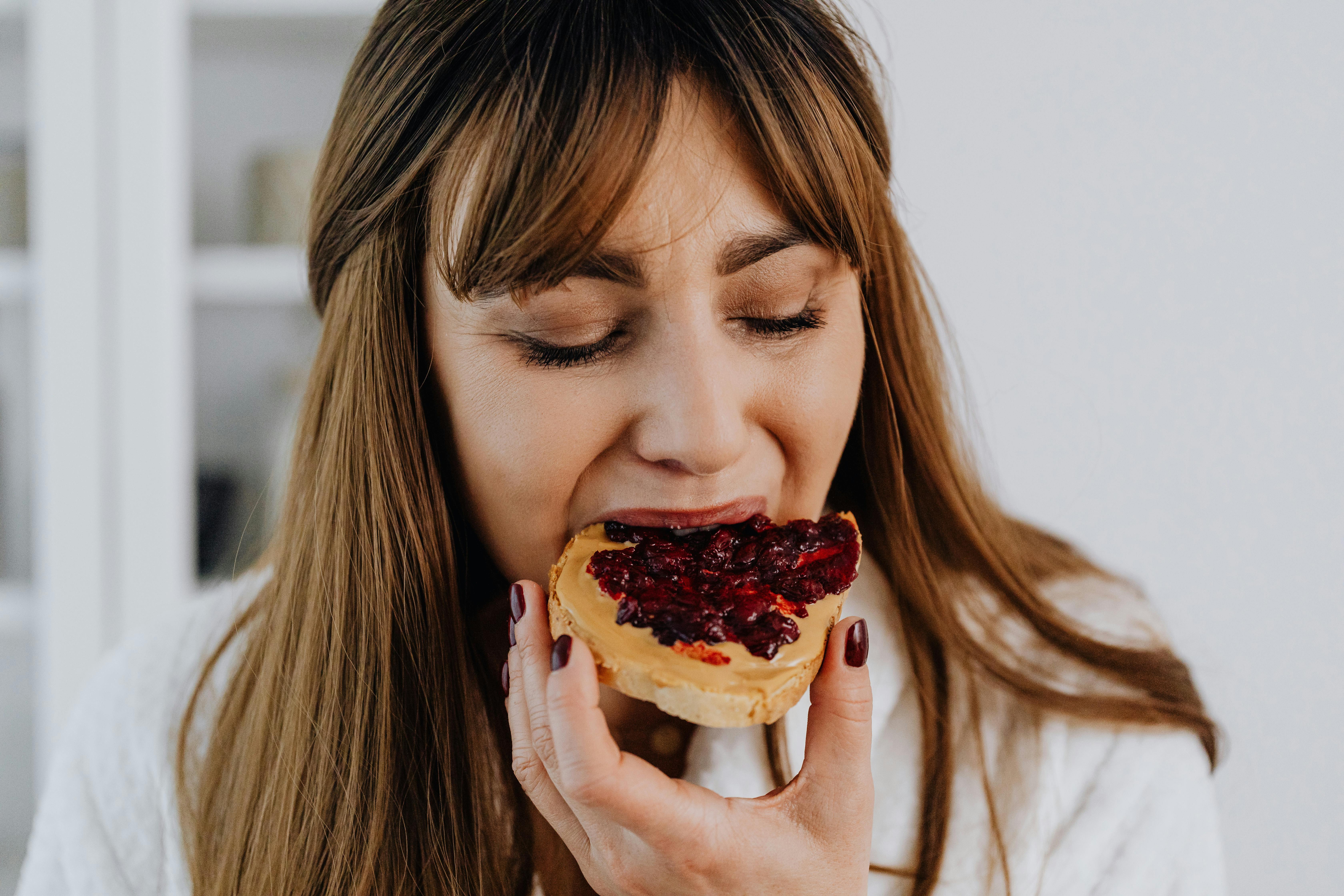 A Woman Eating Bread · Free Stock Photo