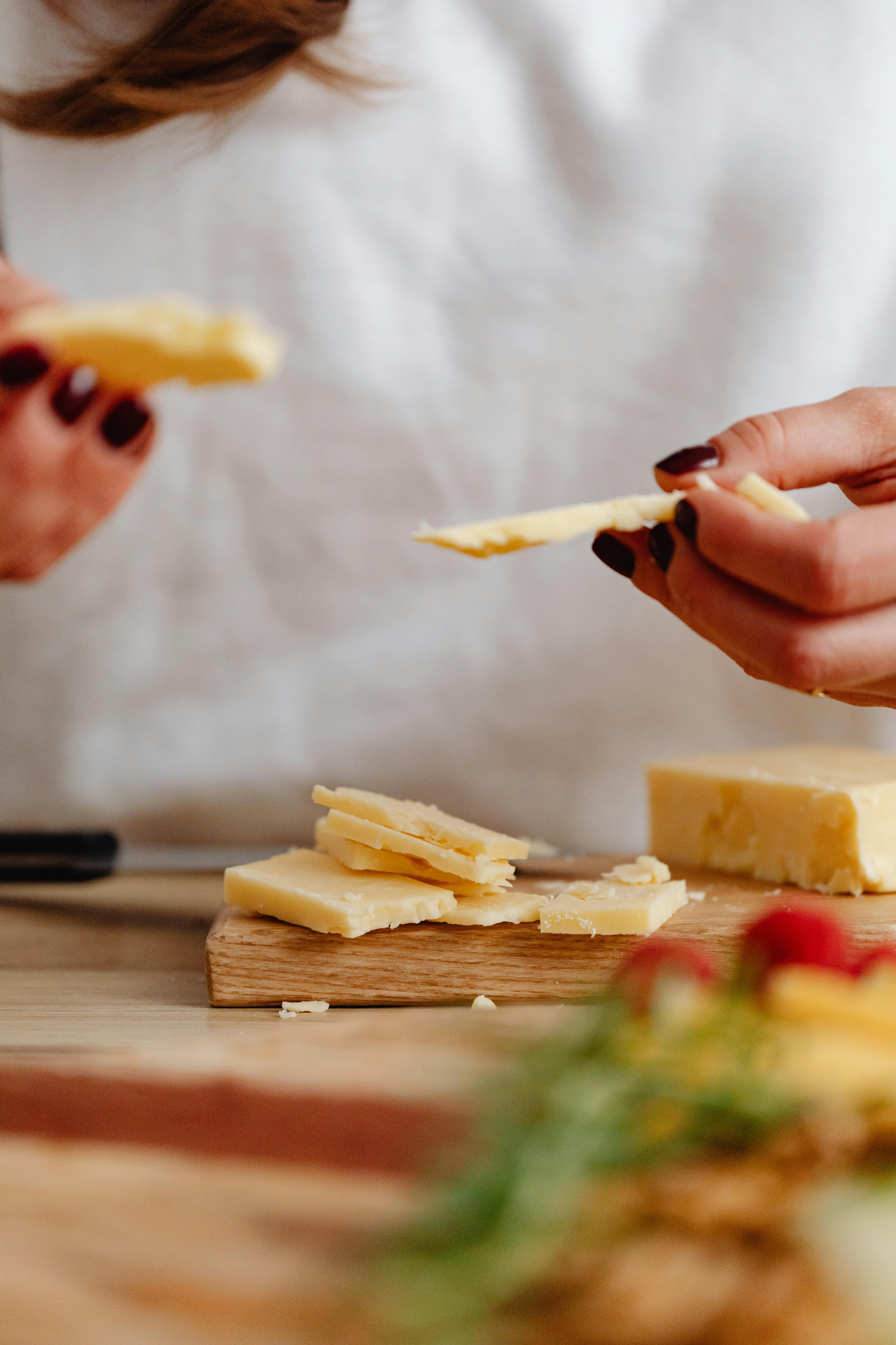Close-Up Photo of a Person's Hands Holding Cheese · Free Stock Photo