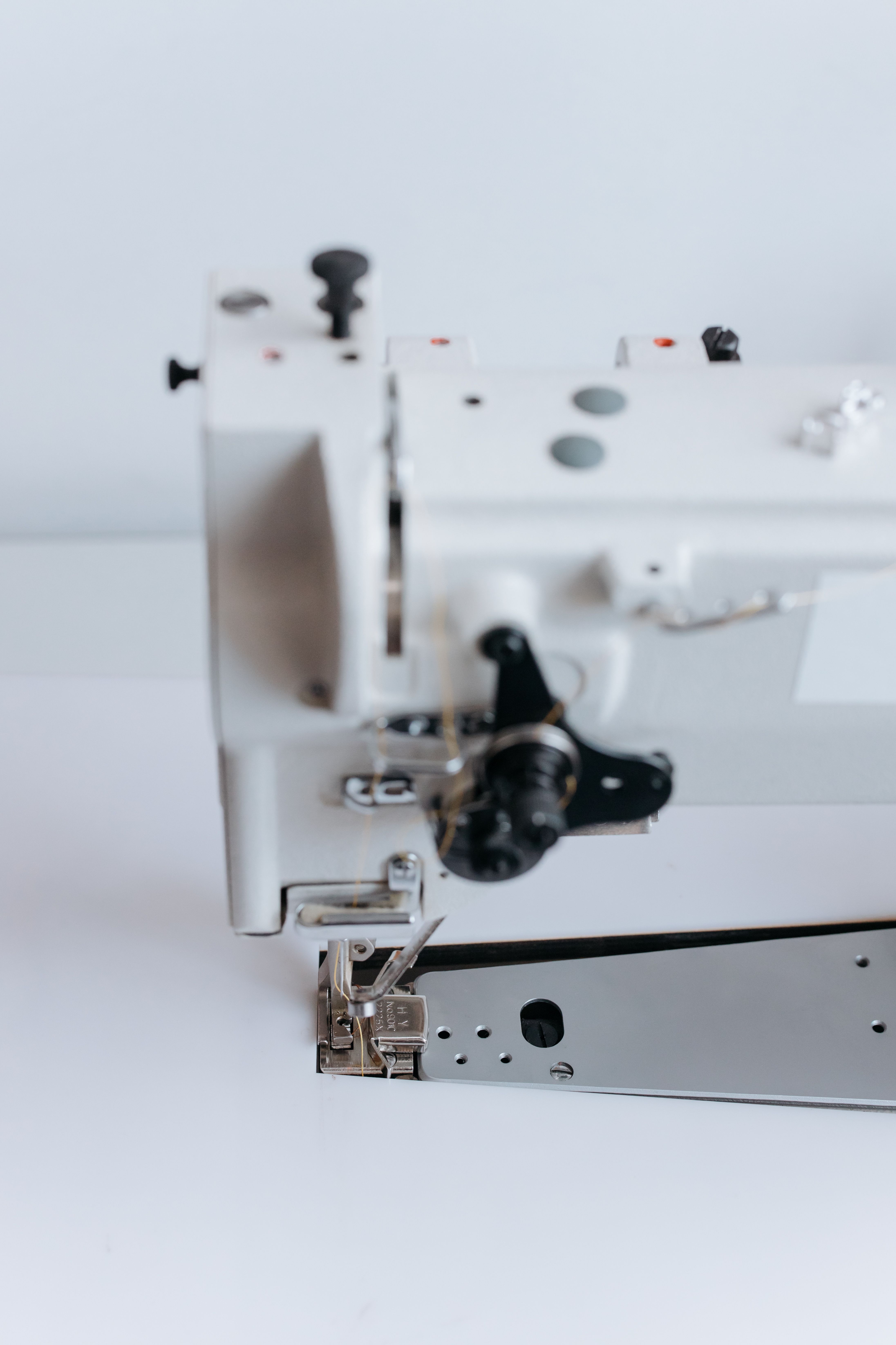 A White Sewing Machine with Stainless Throat Plate and Black Knobs ...