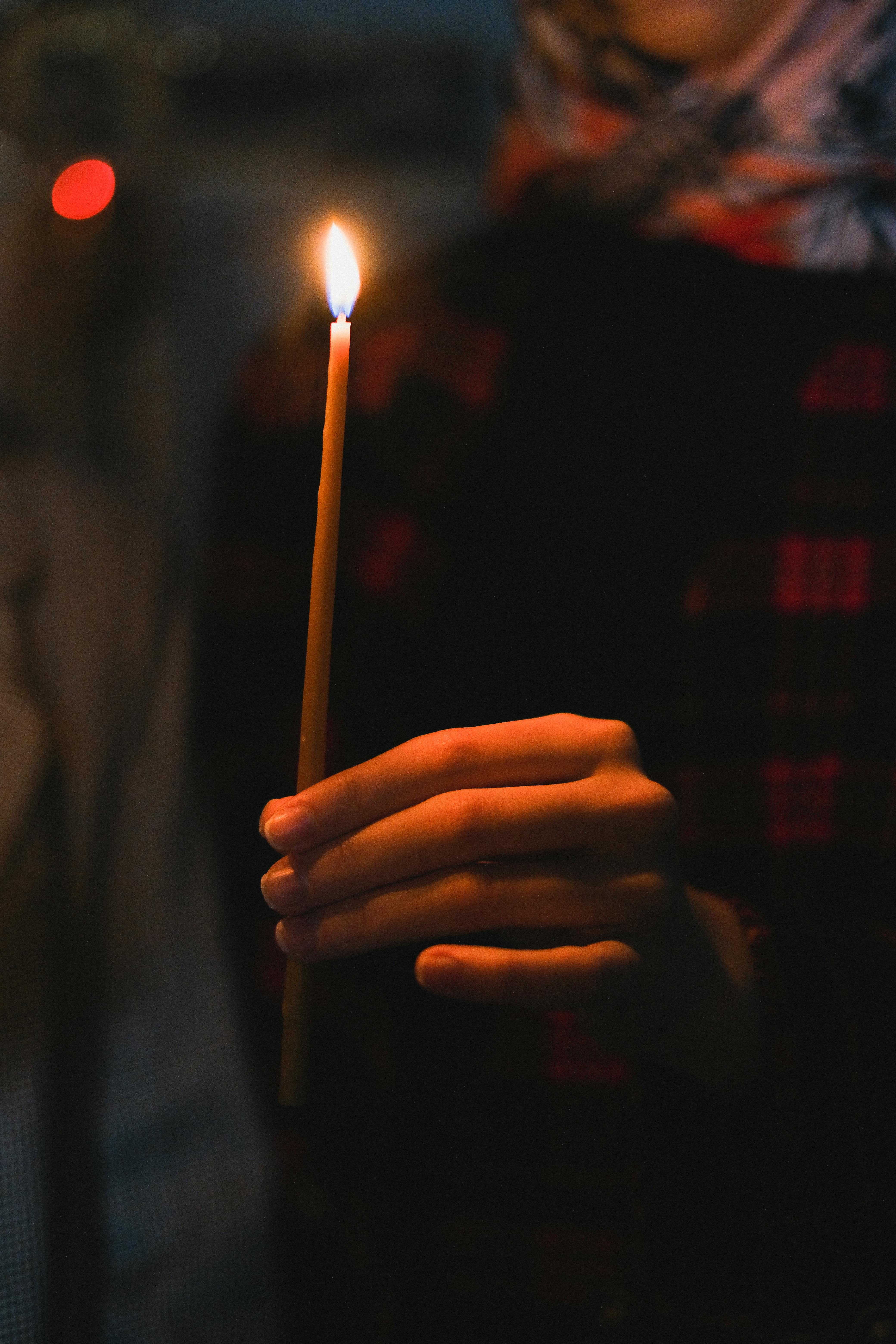A Person Holding a Lighted Candle · Free Stock Photo