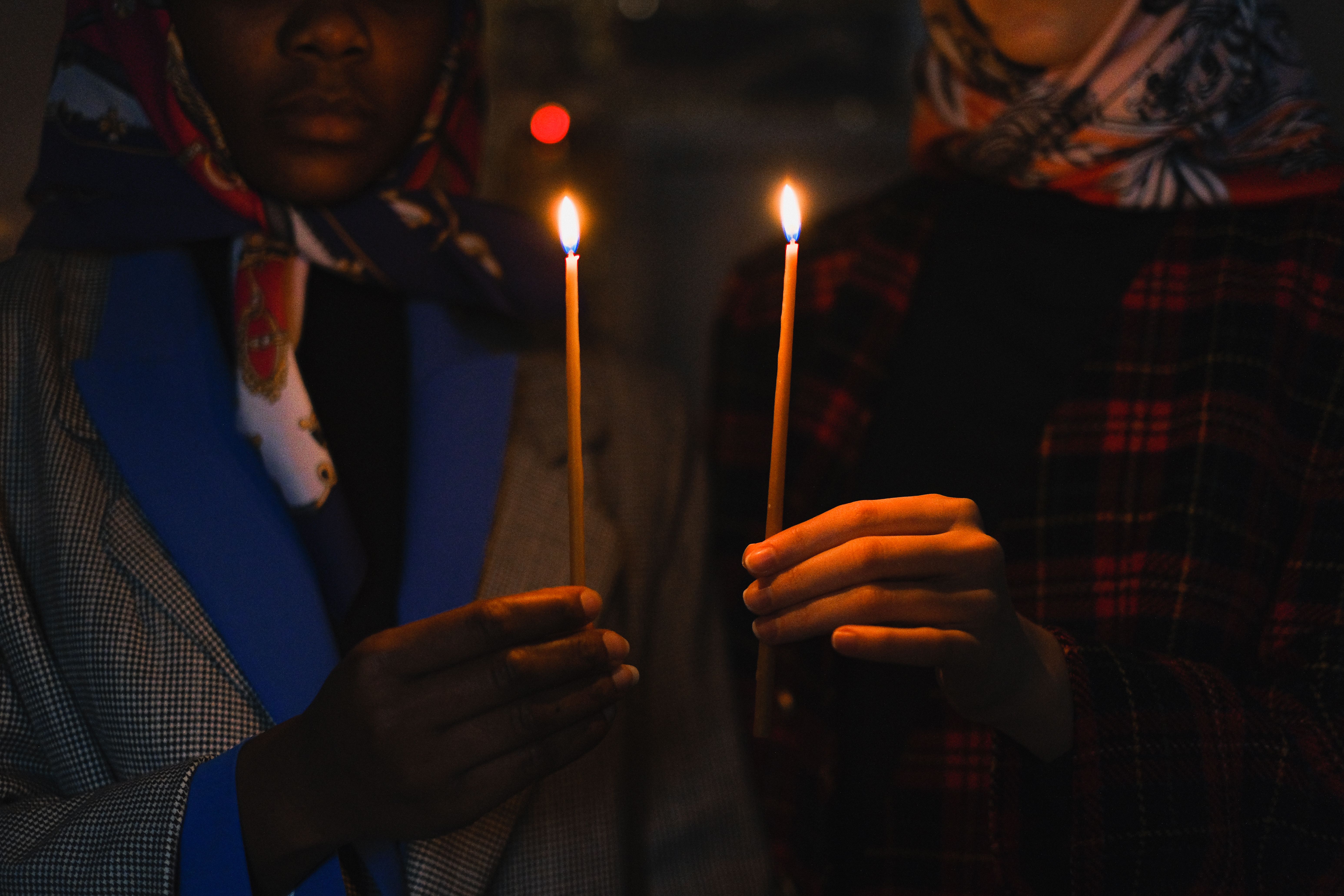 Two Women Holding Lighted Candles · Free Stock Photo
