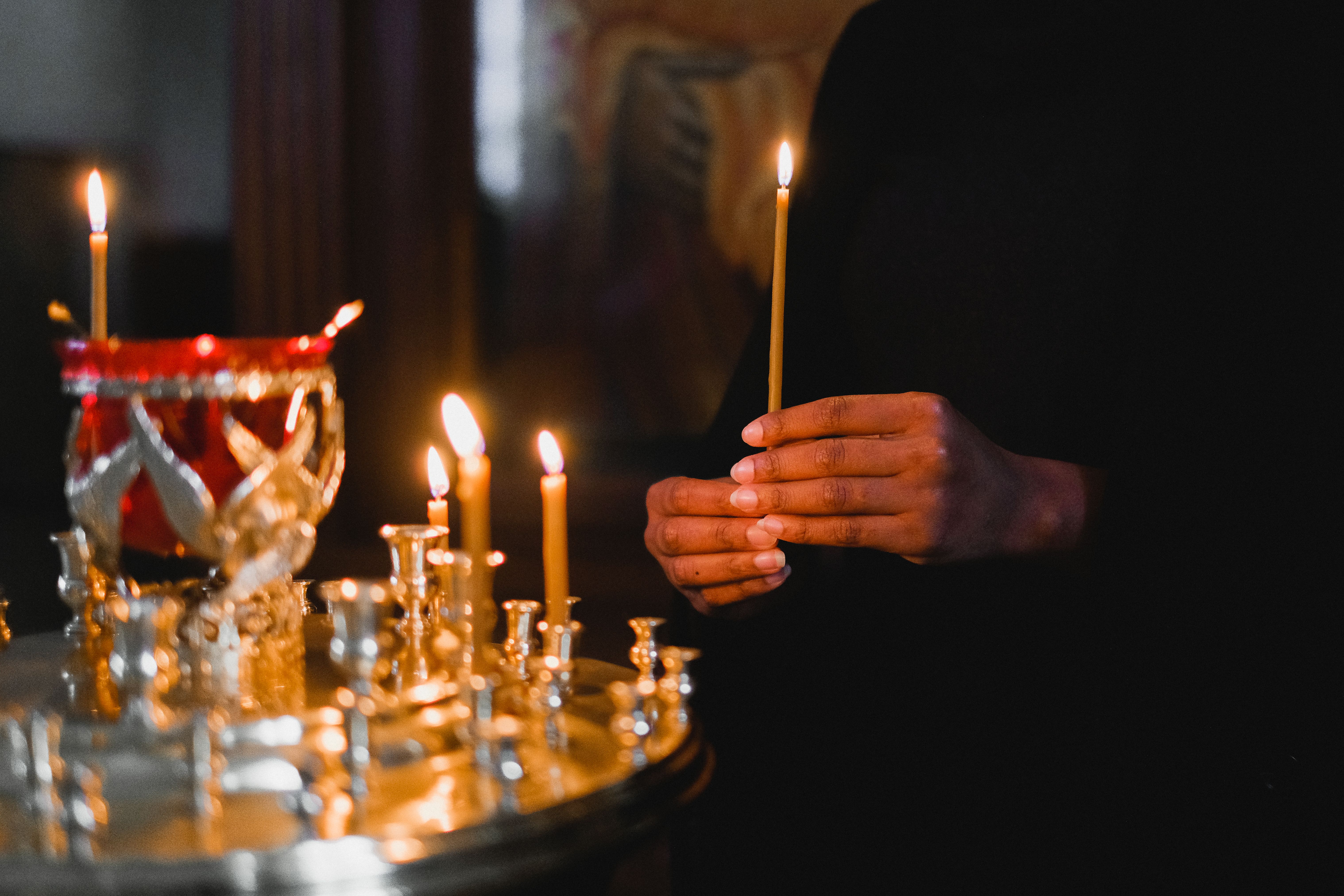 Person Standing Near Burning Candles · Free Stock Photo