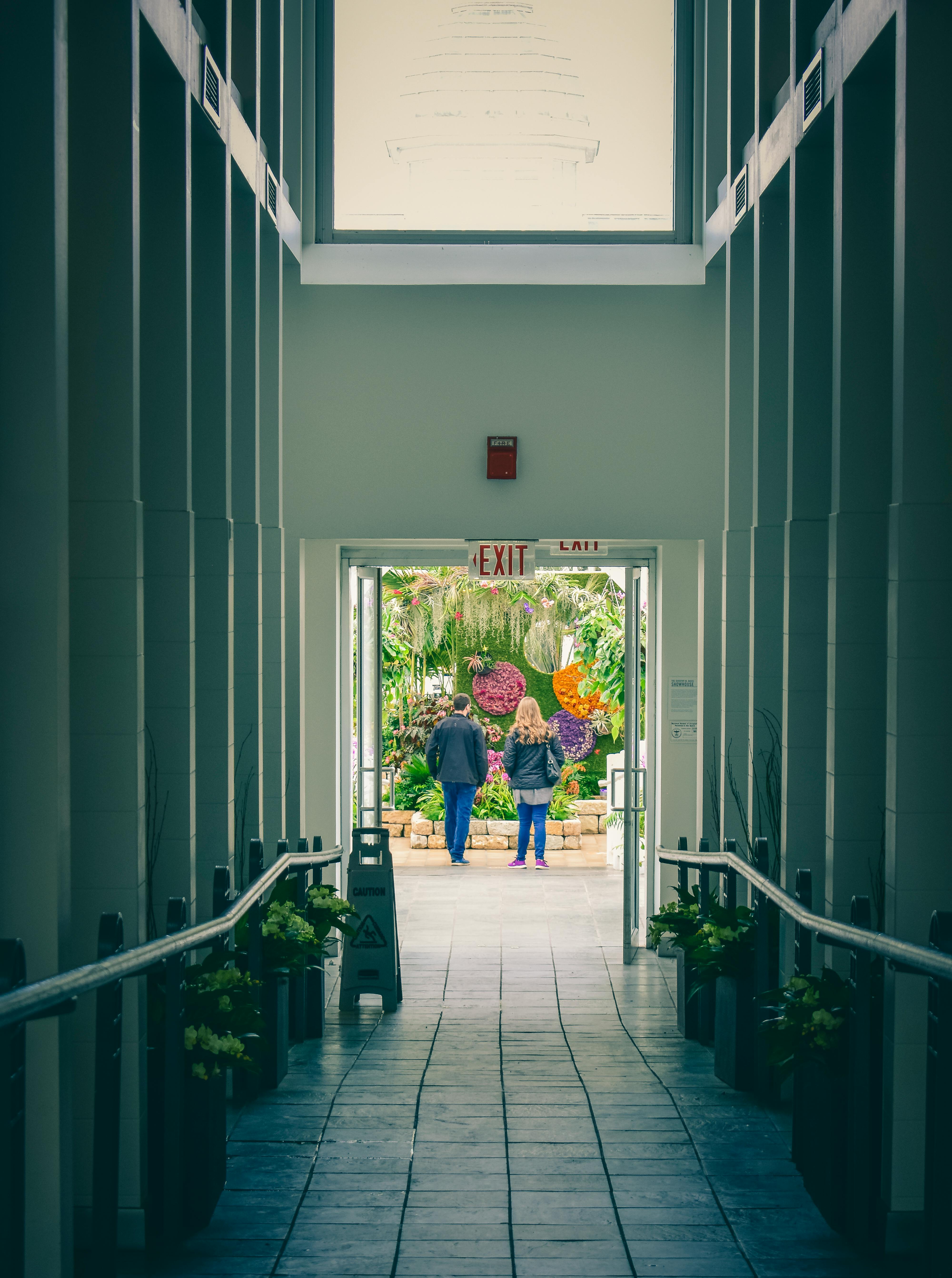 A Hallway towards the Emergency Exit of a Building · Free Stock Photo