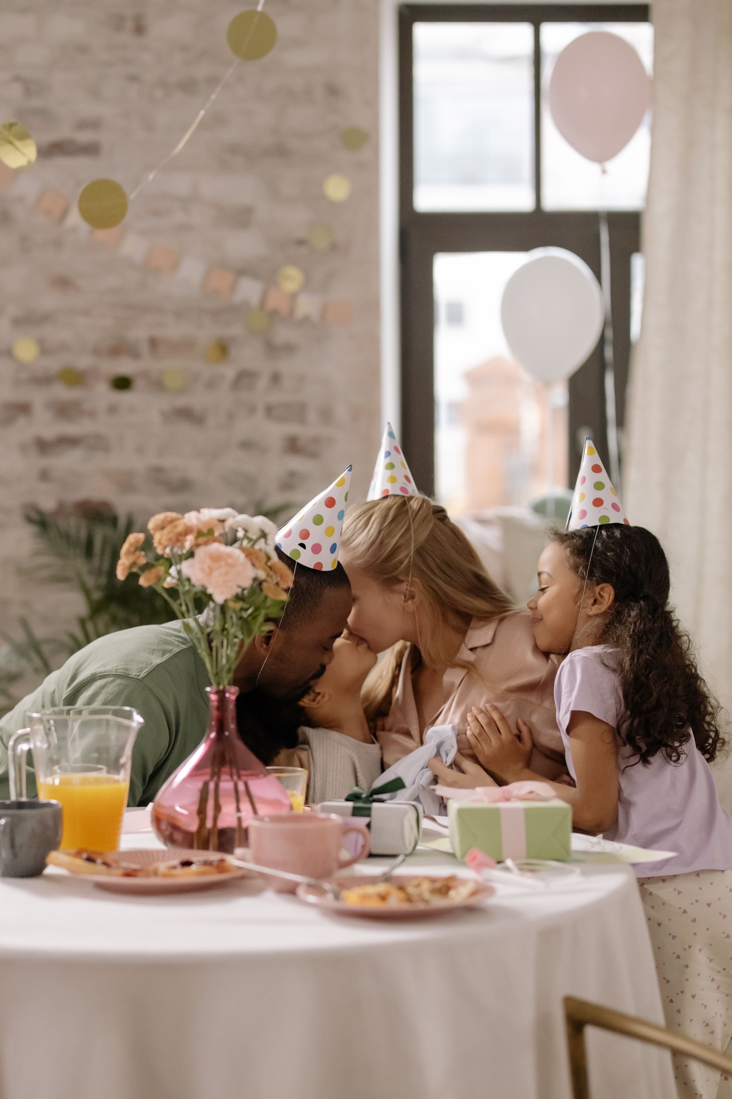 A Happy Family Embracing Each Other Near the Table · Free Stock Photo