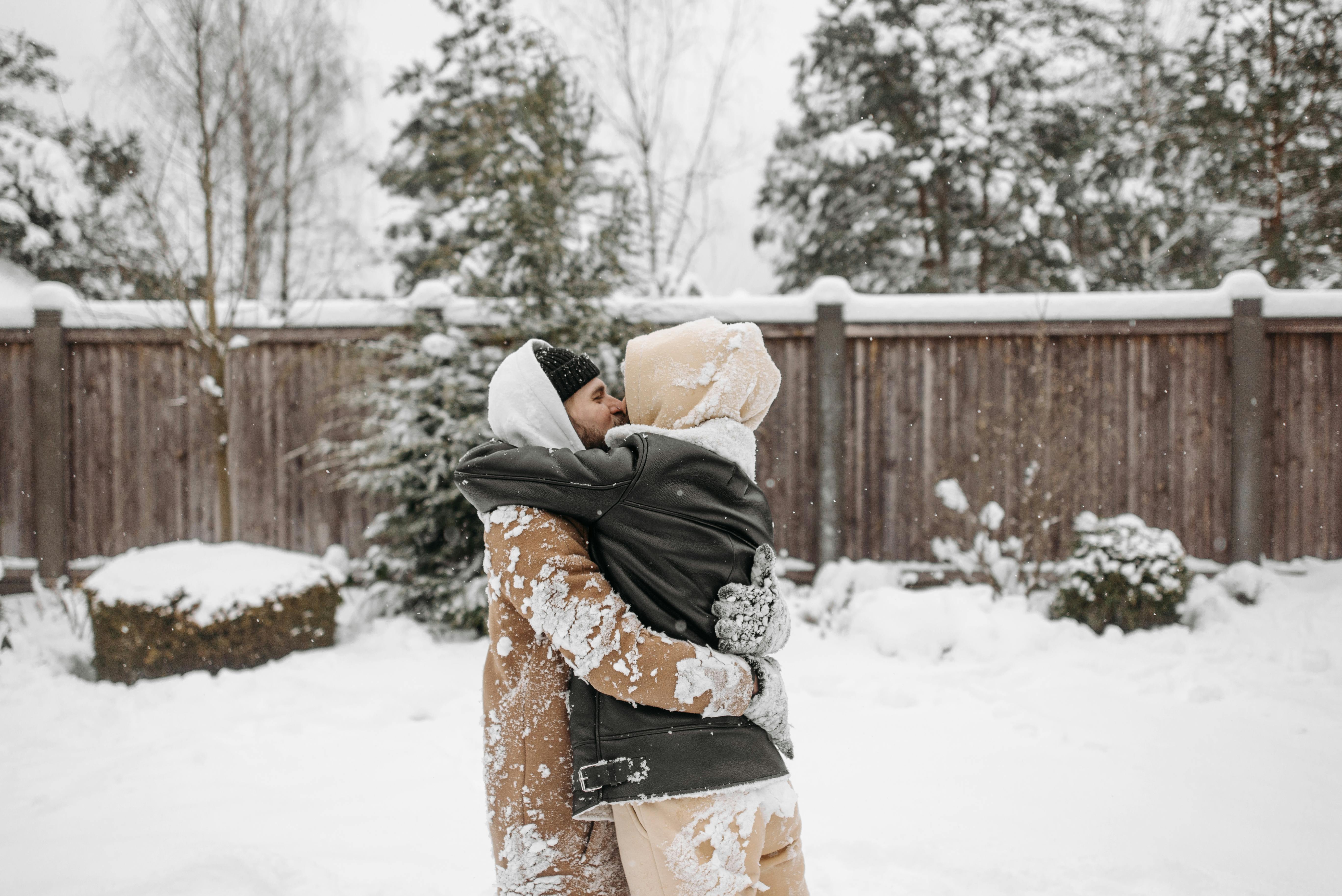 A Couple in Winter Clothes Embracing Each Other · Free Stock Photo