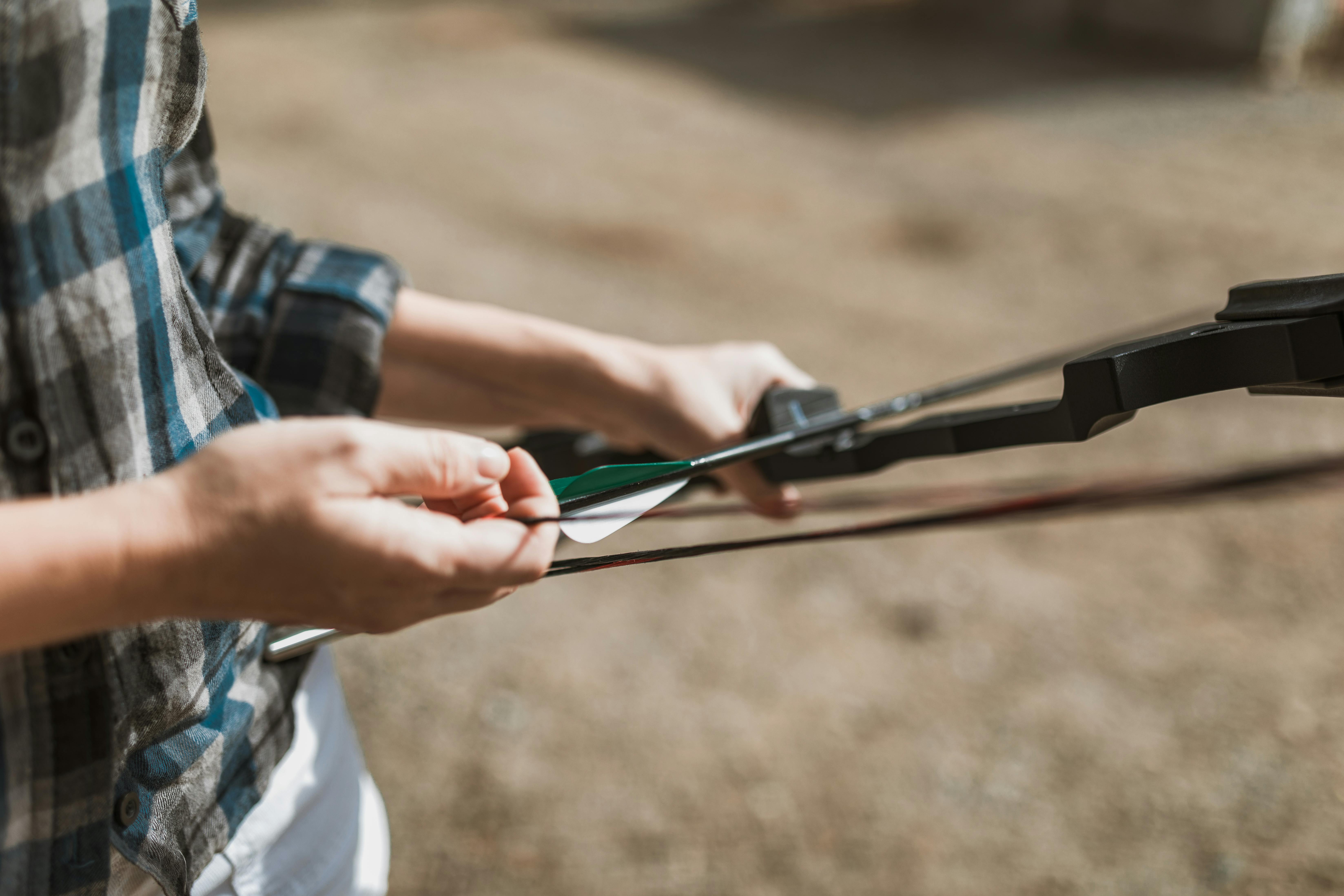 Person Holding a Bow and Arrow · Free Stock Photo