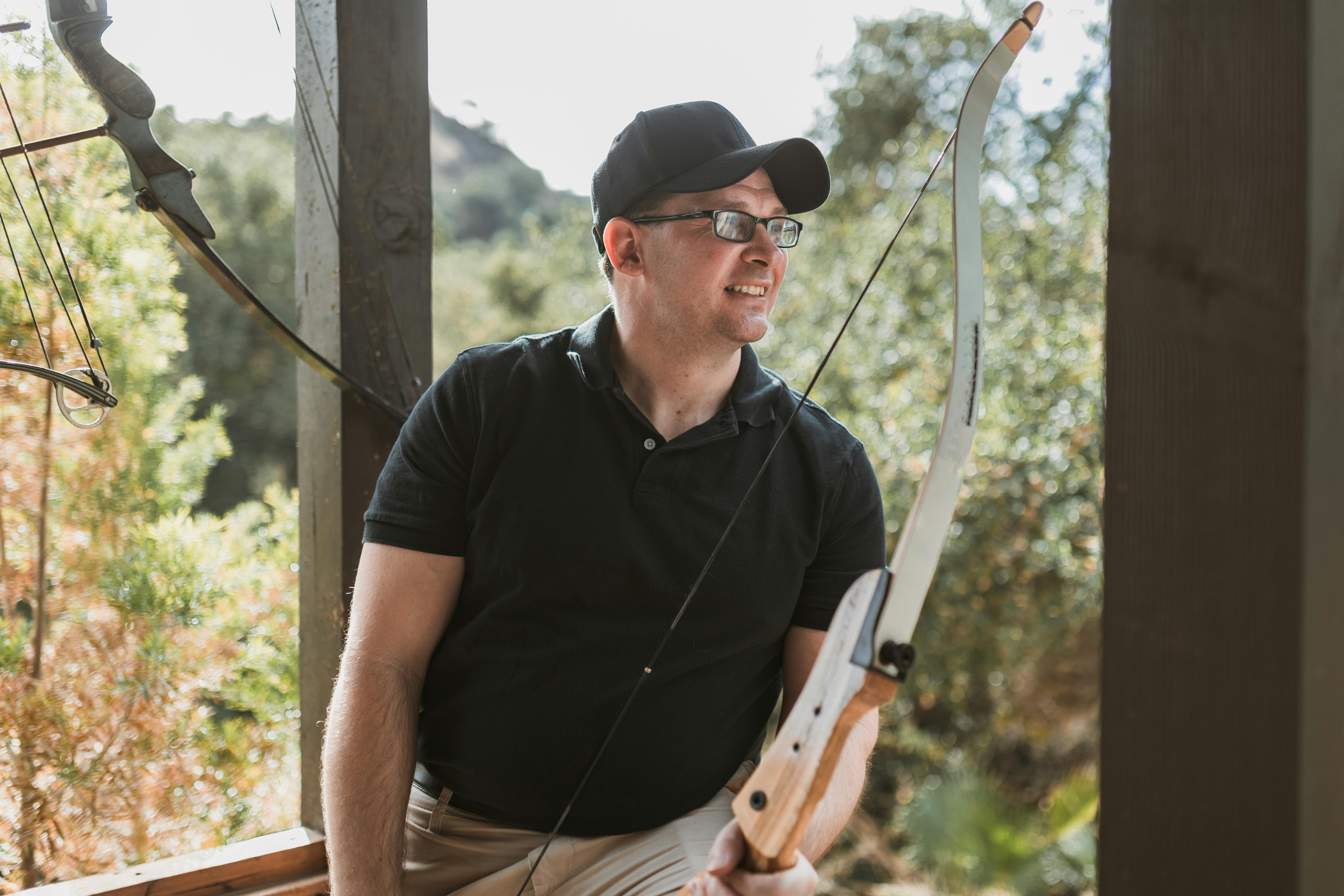 A Man Holding a Bow · Free Stock Photo