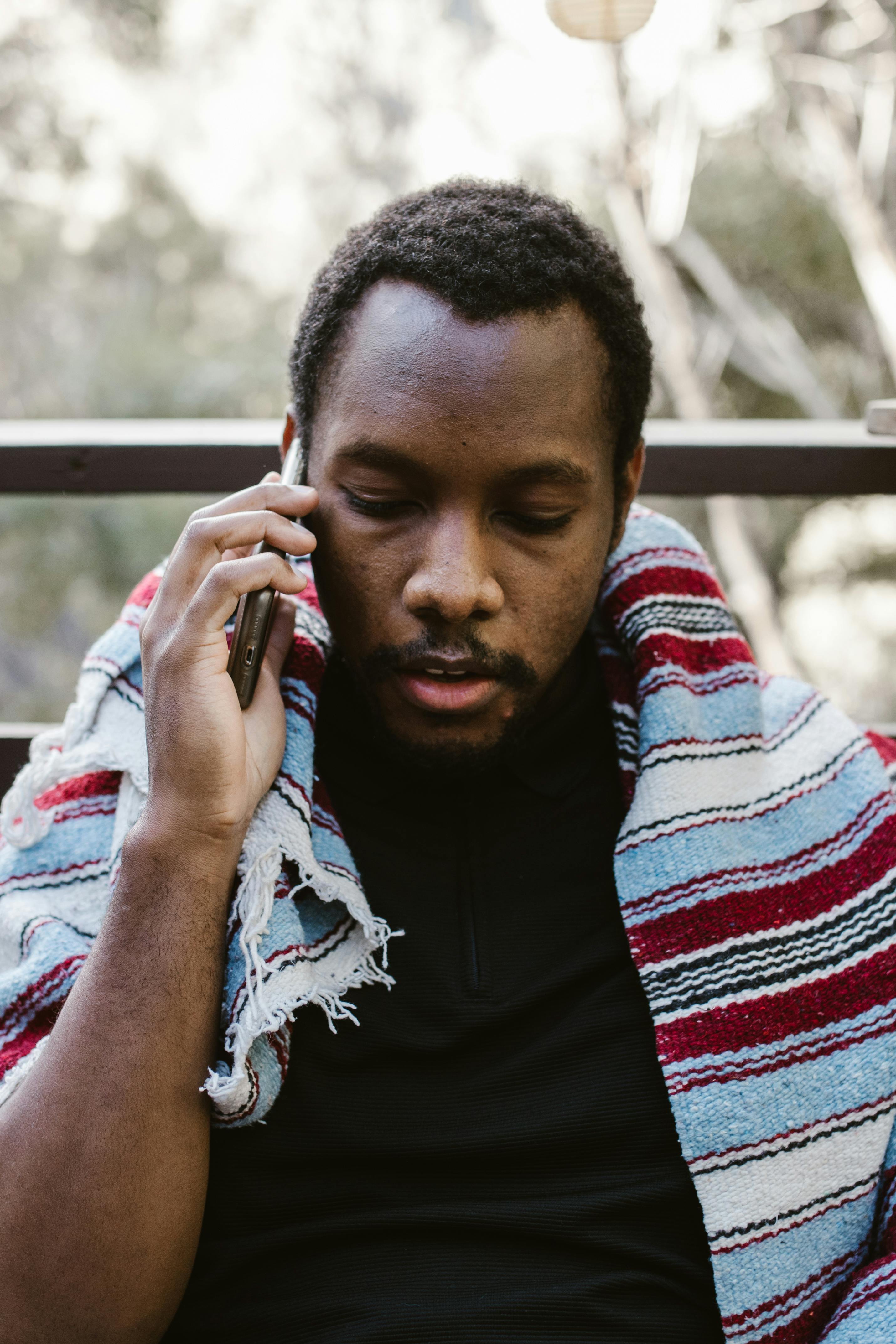 A Sad Man Talking on the Phone · Free Stock Photo
