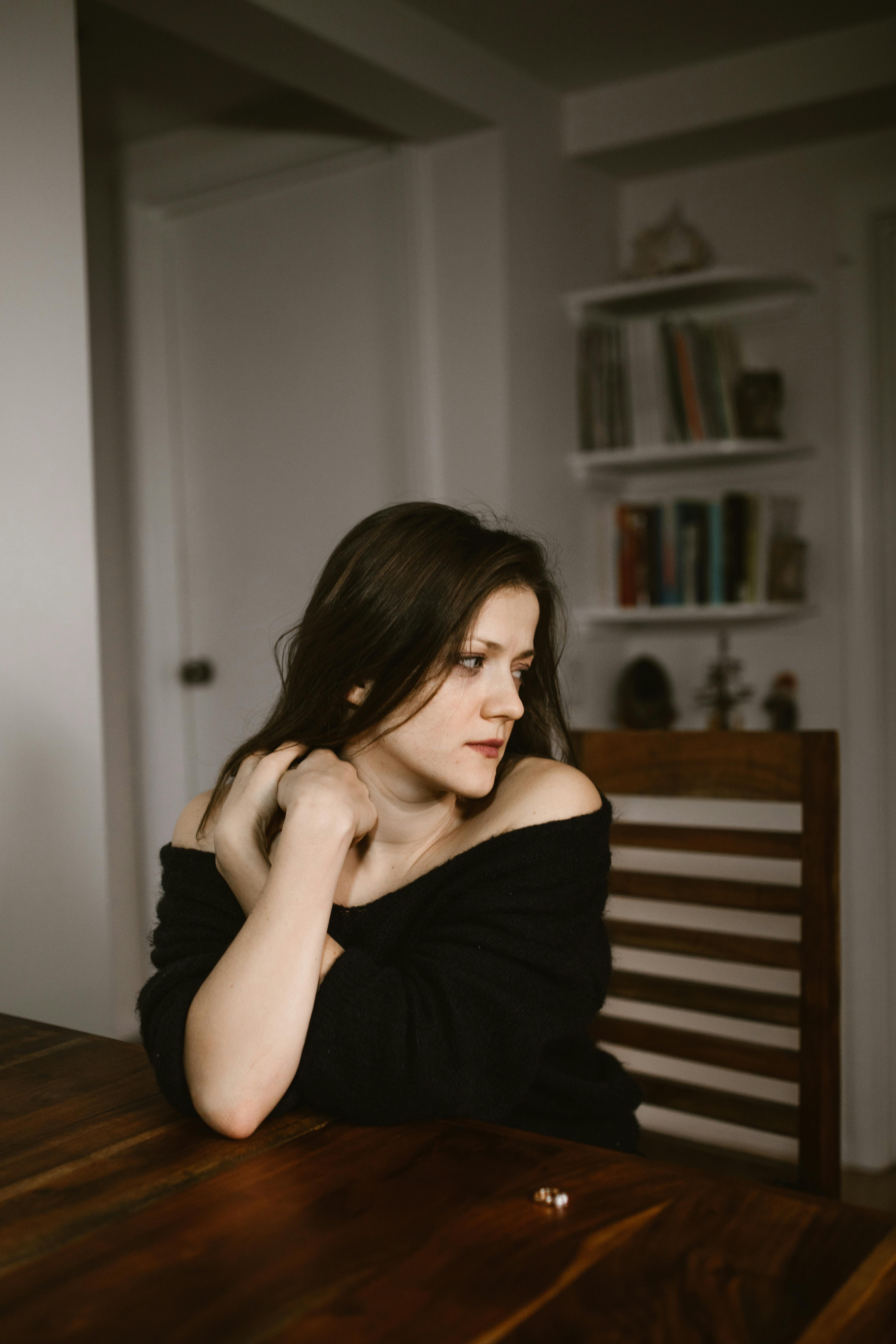 A Woman Sitting at the Table · Free Stock Photo