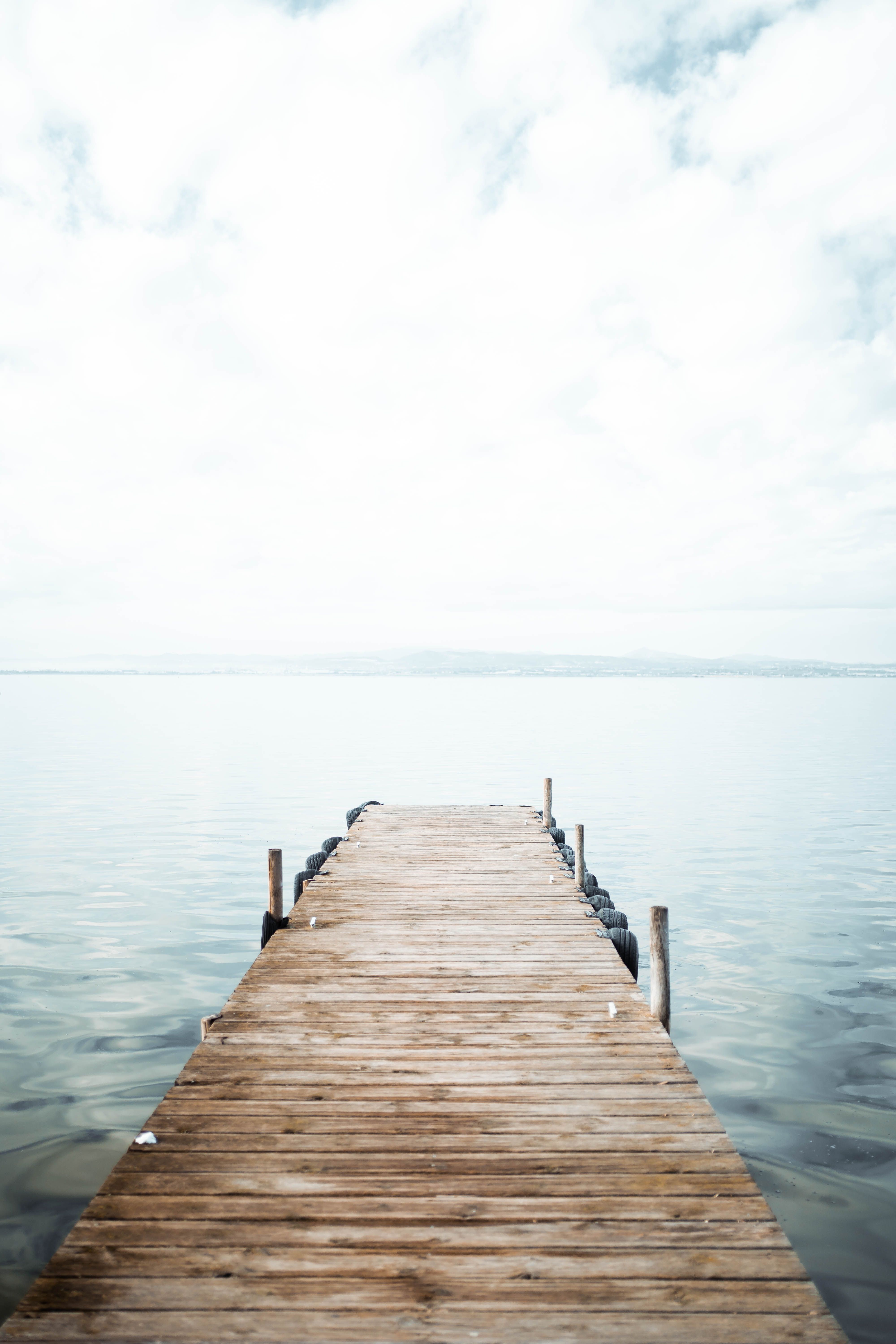 Wooden Dock near Ocean under the Cloudy Sky · Free Stock Photo