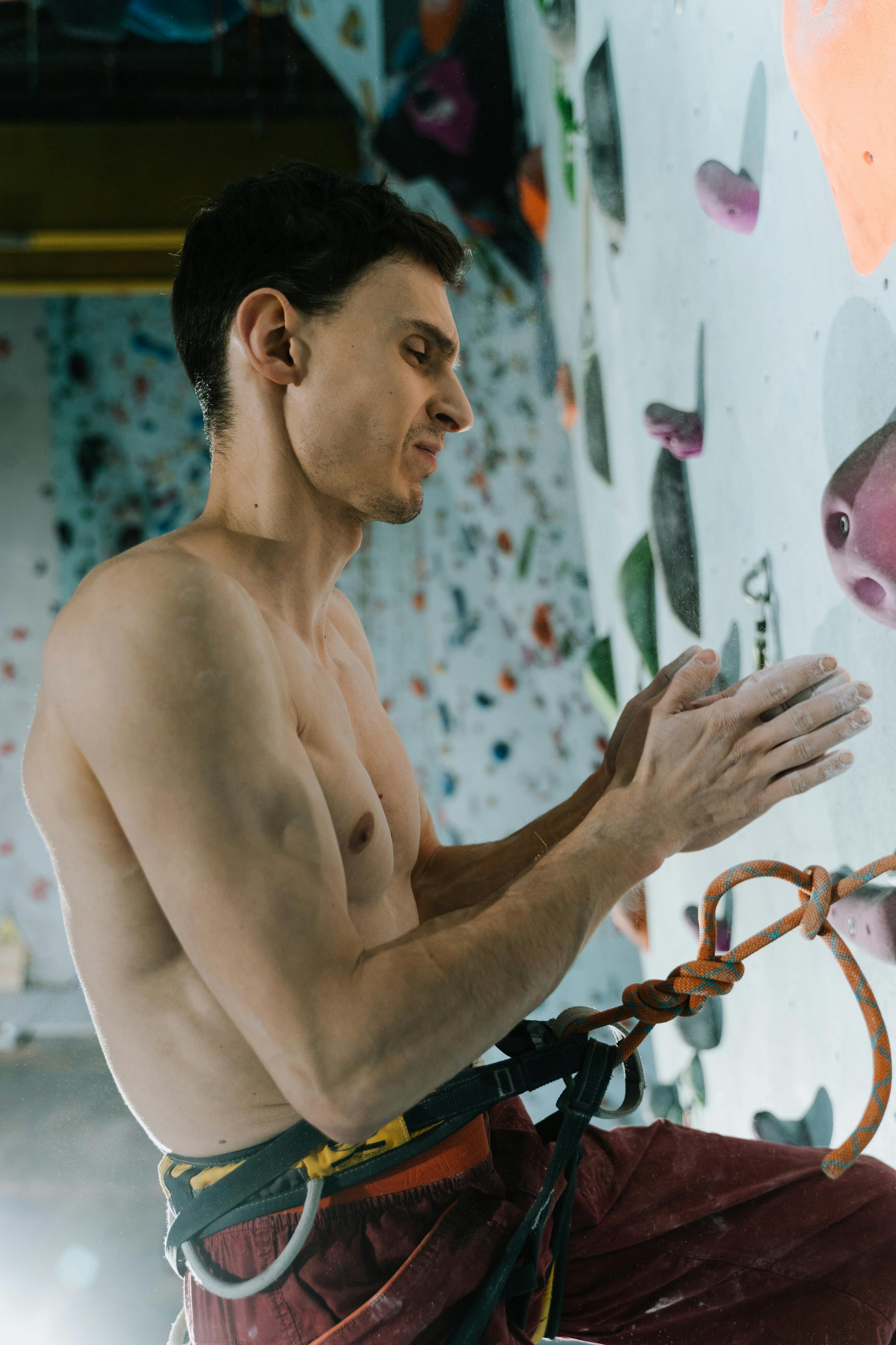 A Shirtless Man Bouldering a Wall · Free Stock Photo