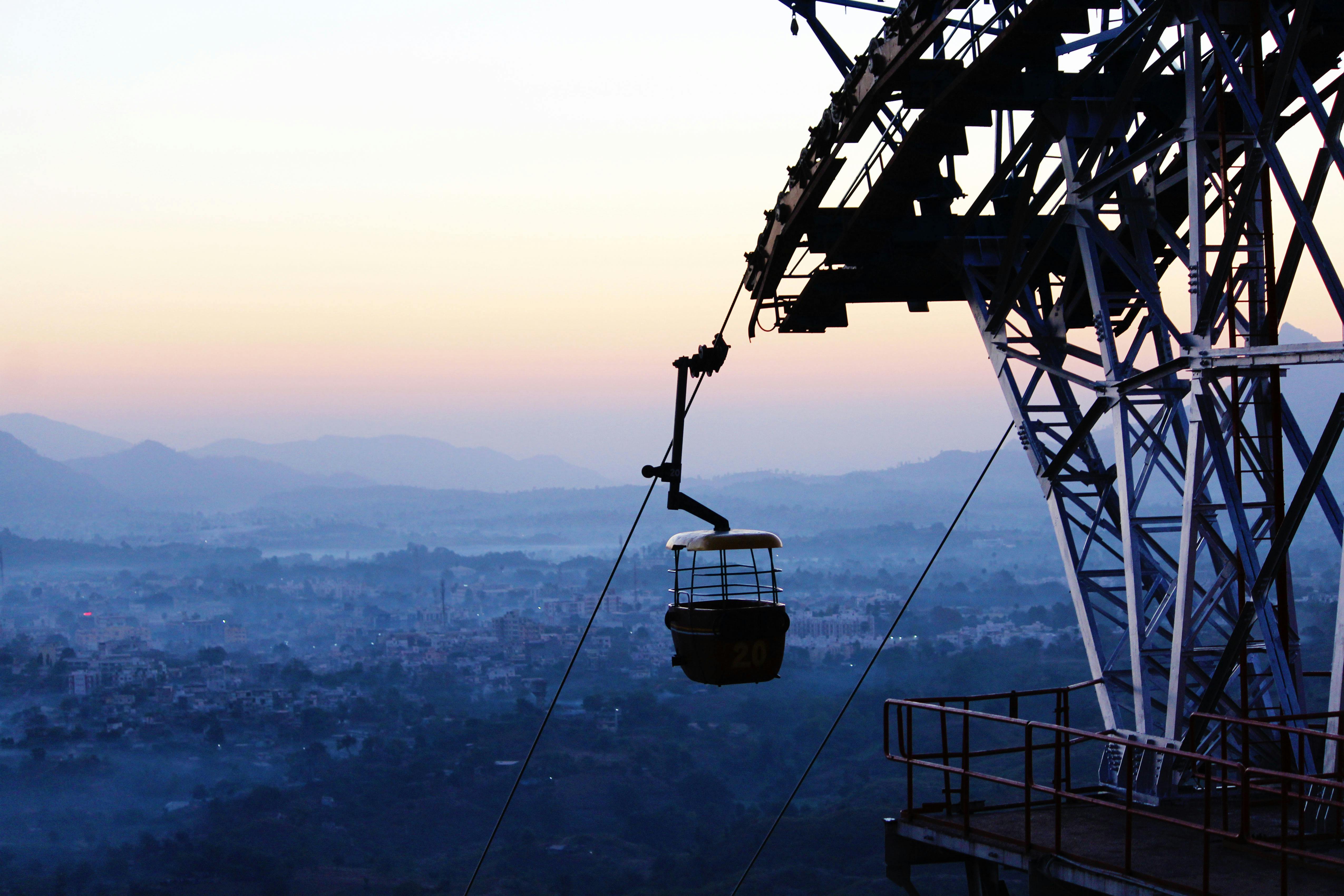 White Zip Line Bus Above on Green Leaved Trees · Free Stock Photo