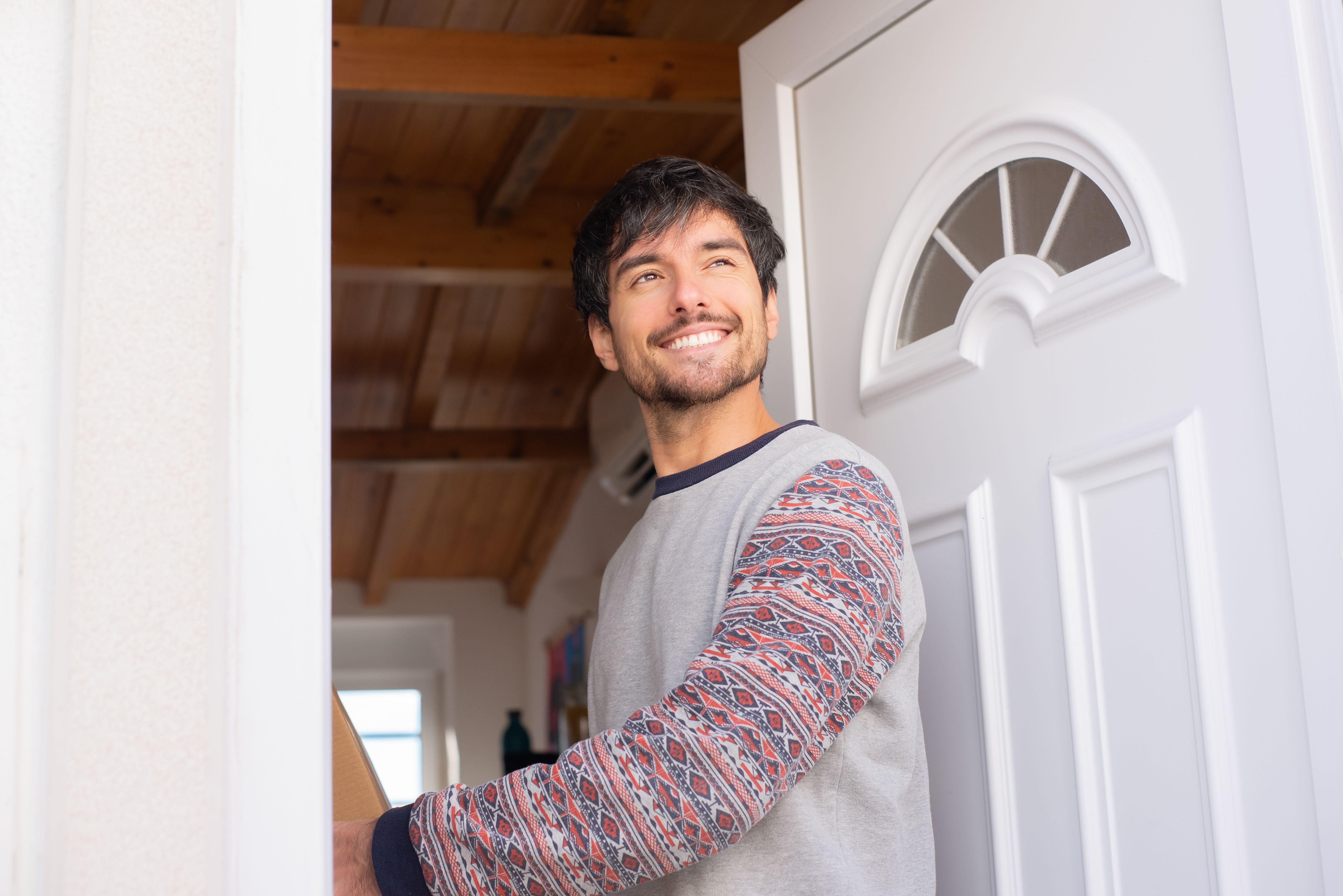 A Woman Standing on the Doorway Welcoming a Man · Free Stock Photo