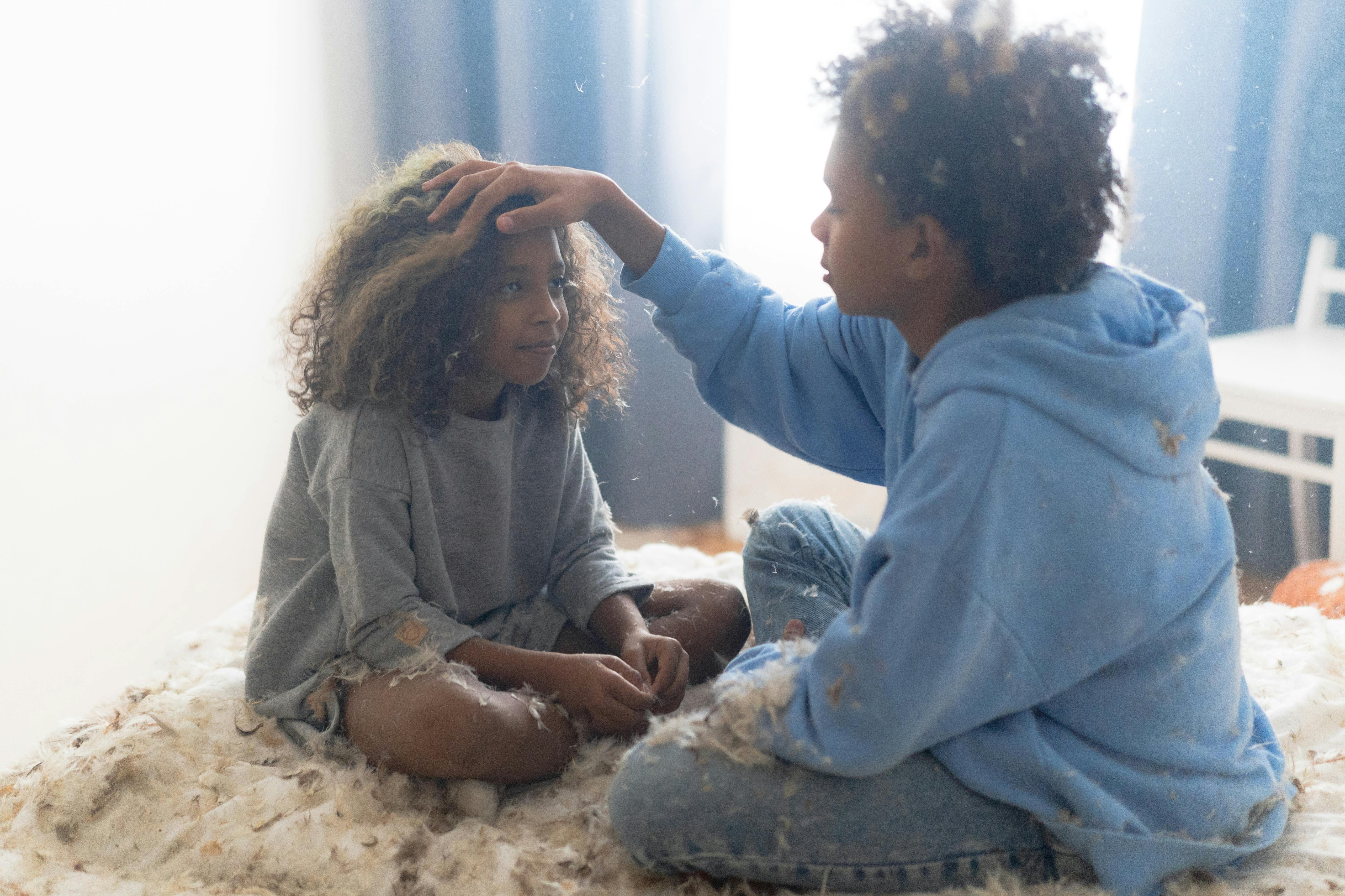 A Boy Touching his Sister's Head · Free Stock Photo