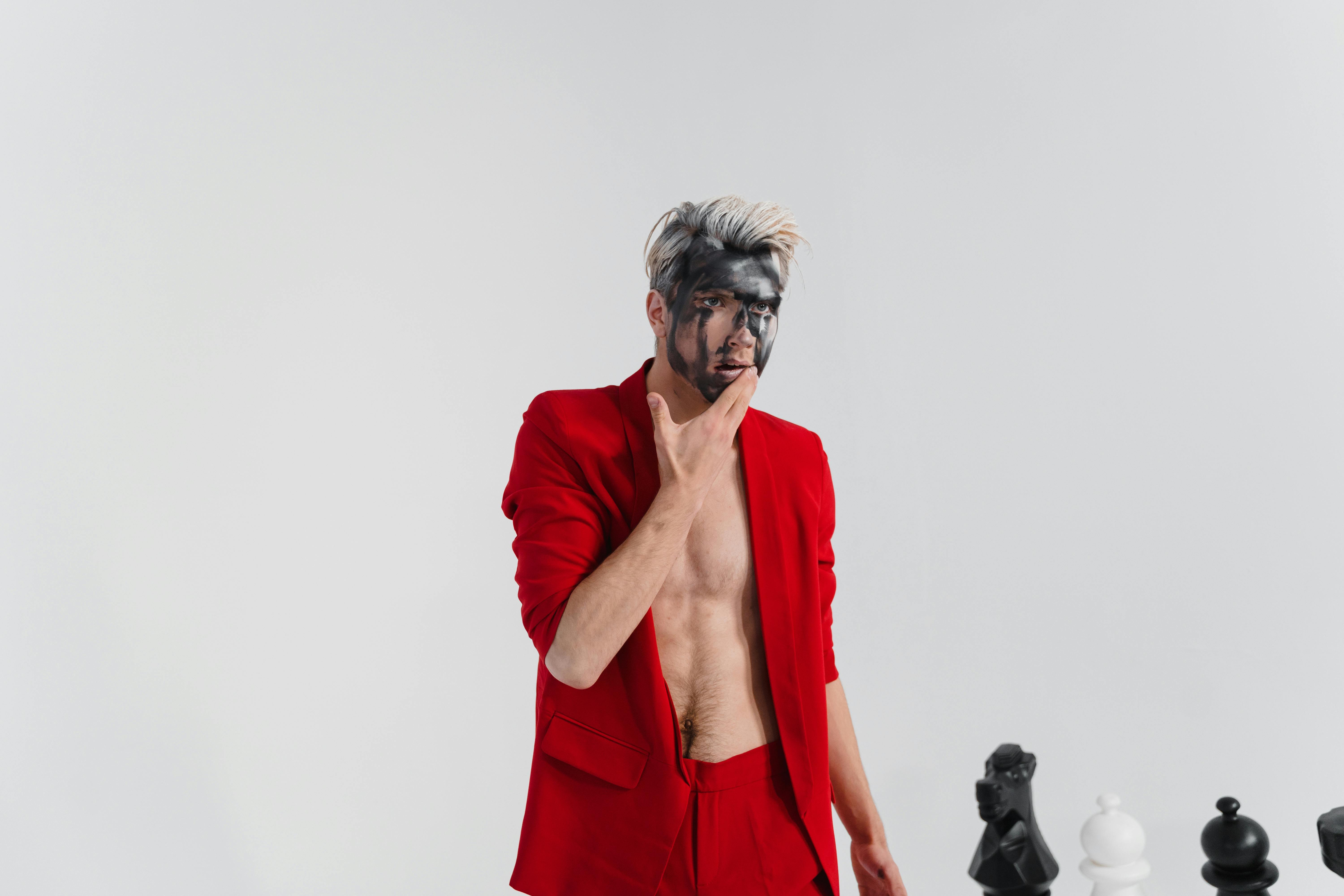 A Portrait of a Man in a Red Suit with Face Paint · Free Stock Photo