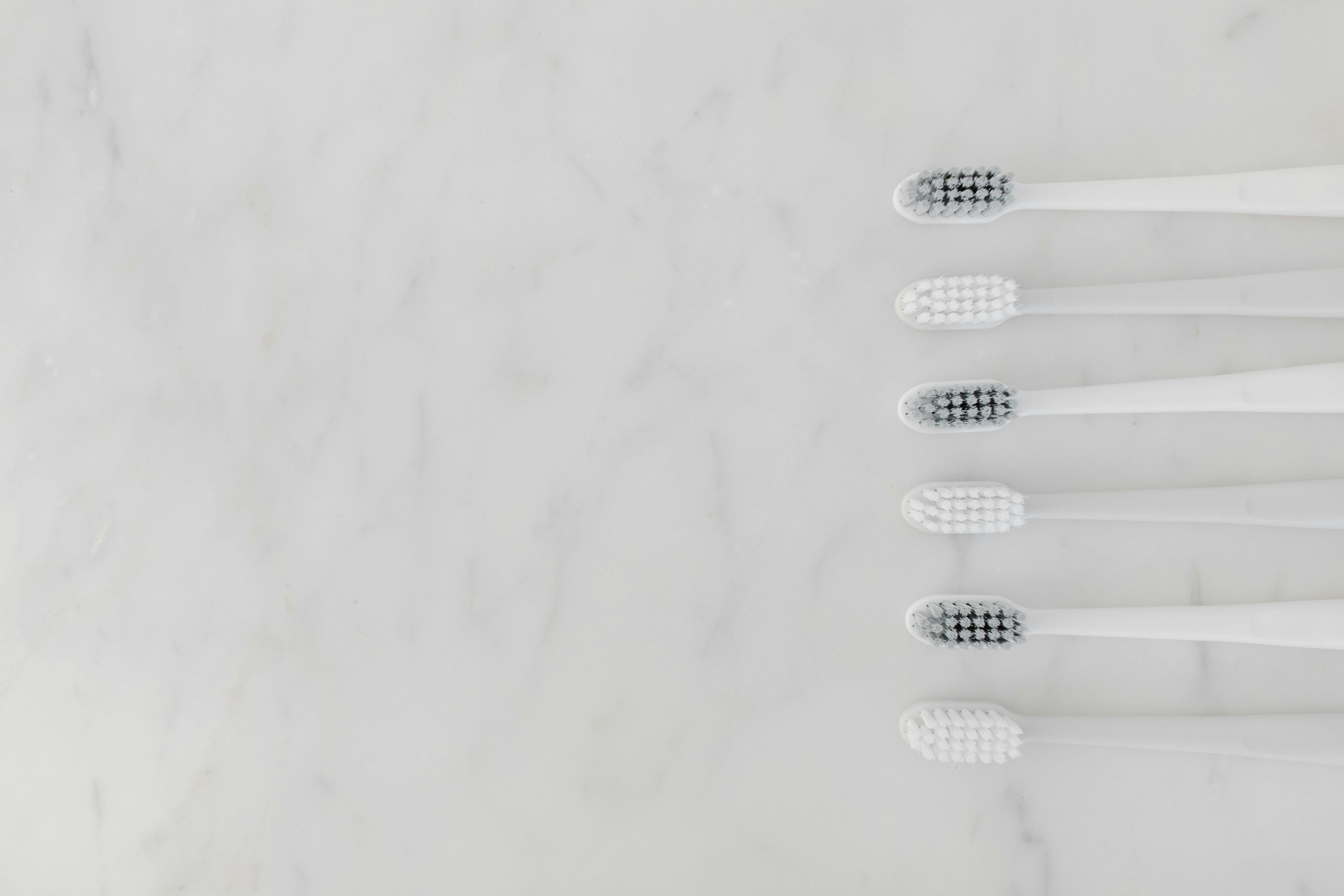 Top View of Toothbrushes on a Marble Surface · Free Stock Photo