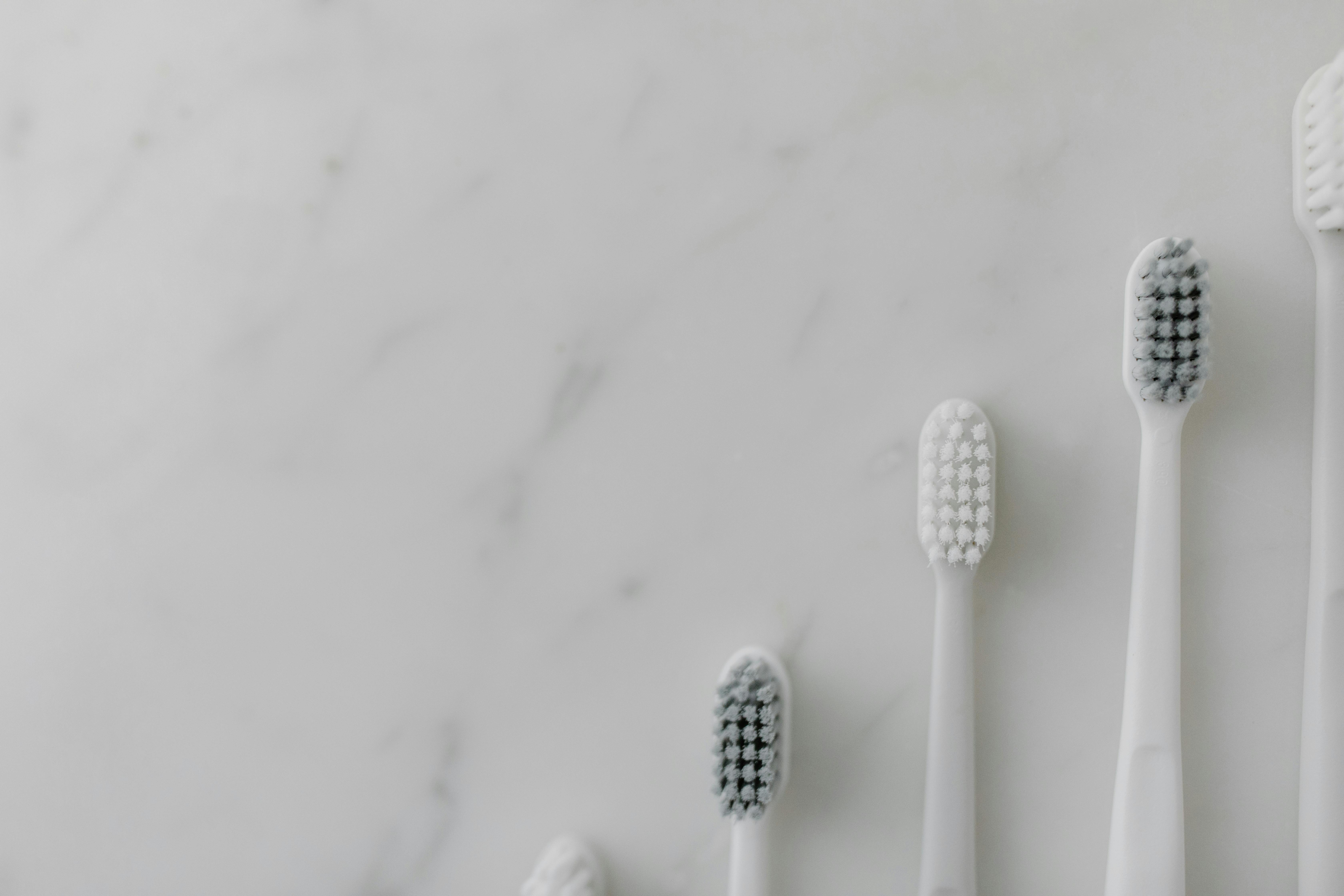 Top View of Toothbrushes on a Marble Surface · Free Stock Photo