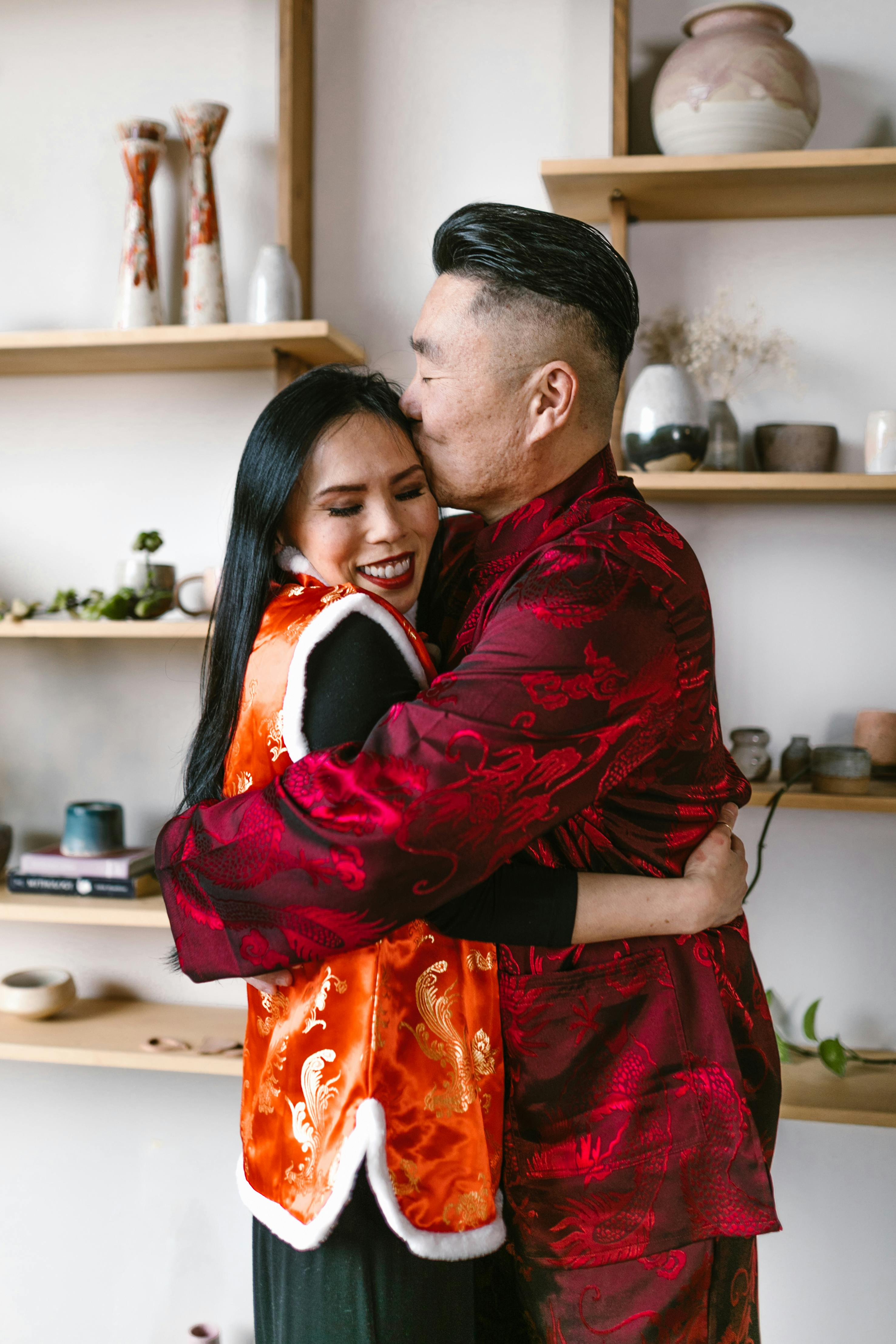 A Couple in Traditional Clothing Hugging Each Other · Free Stock Photo