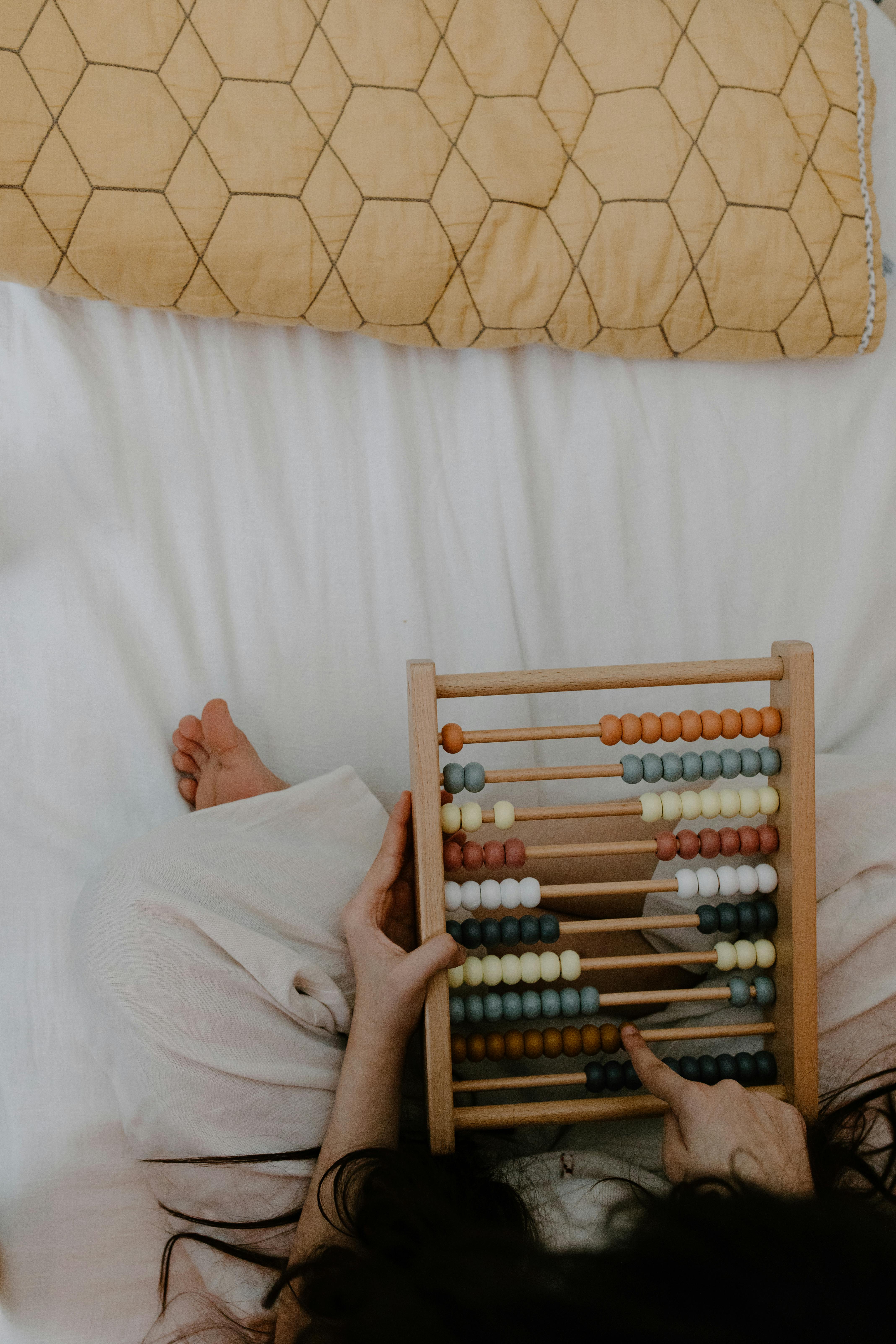 Person Holding an Abacus · Free Stock Photo