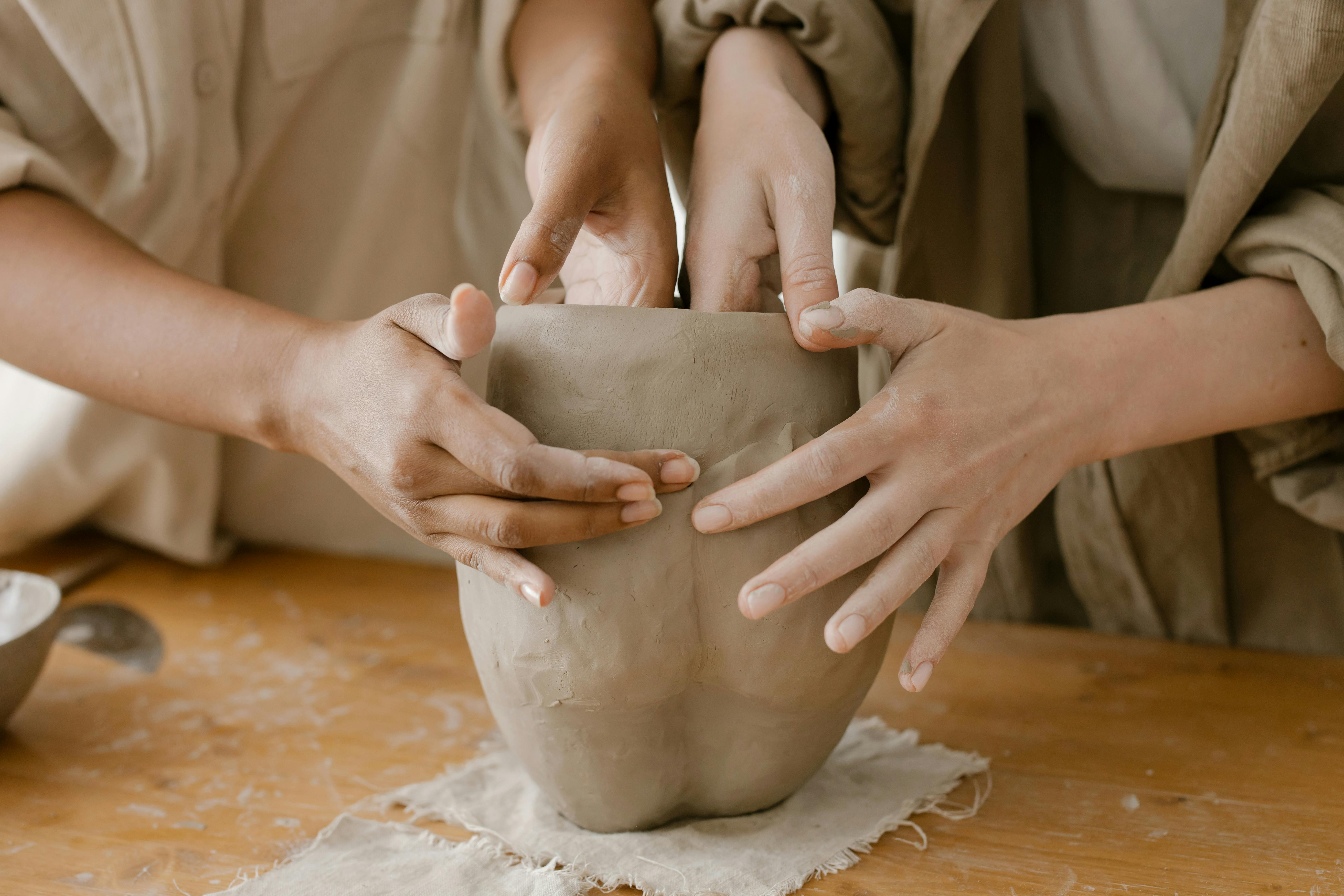 A Close-Up Shot of People Molding a Clay · Free Stock Photo