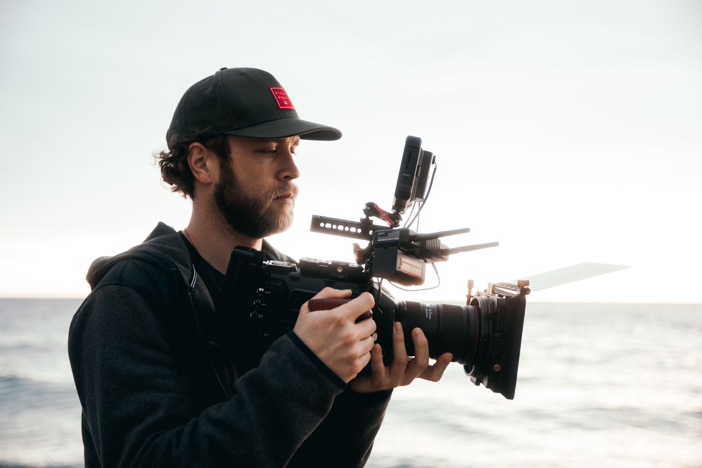 A Man wearing Cap using Camera · Free Stock Photo