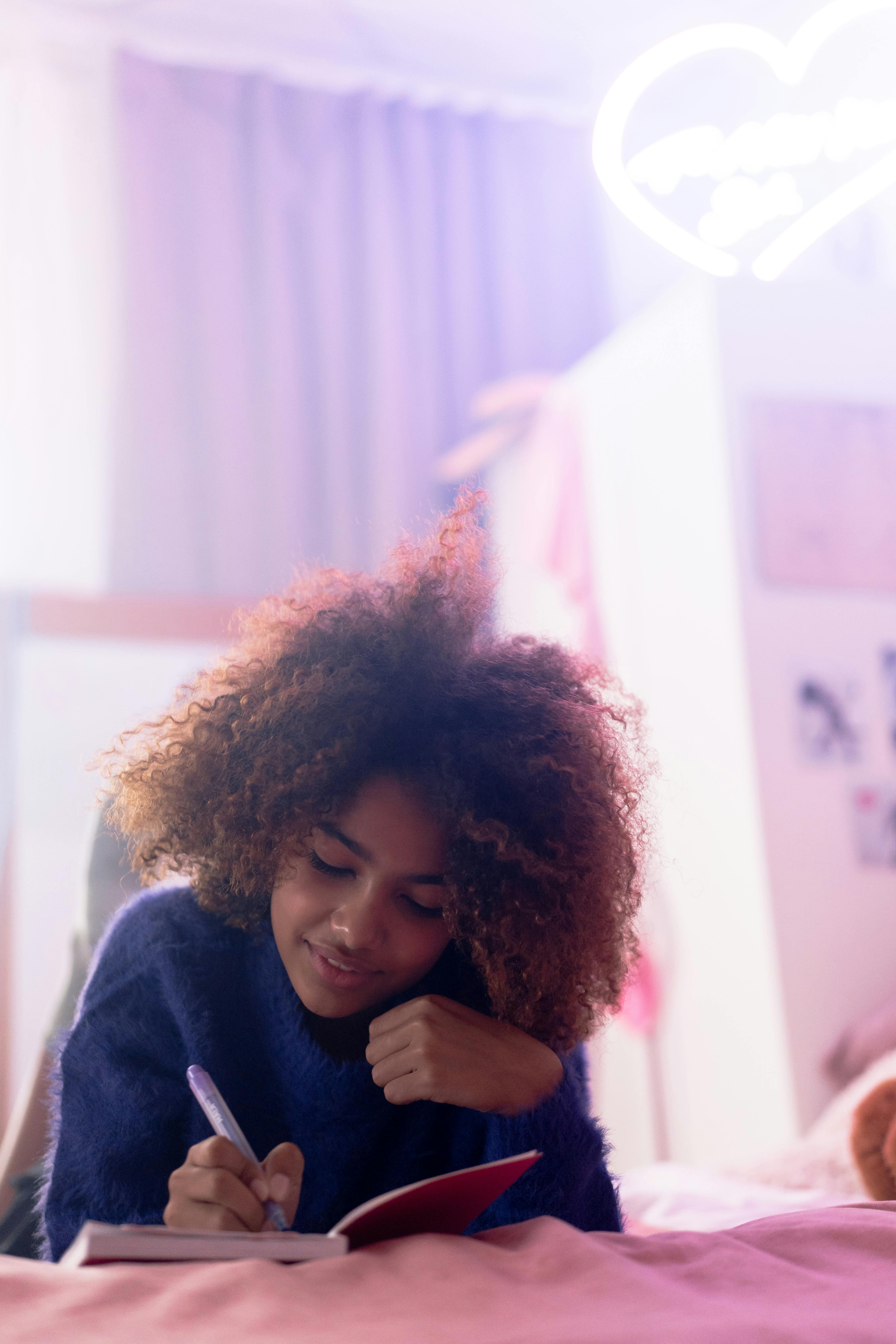 A Woman Writing on the Notebook · Free Stock Photo