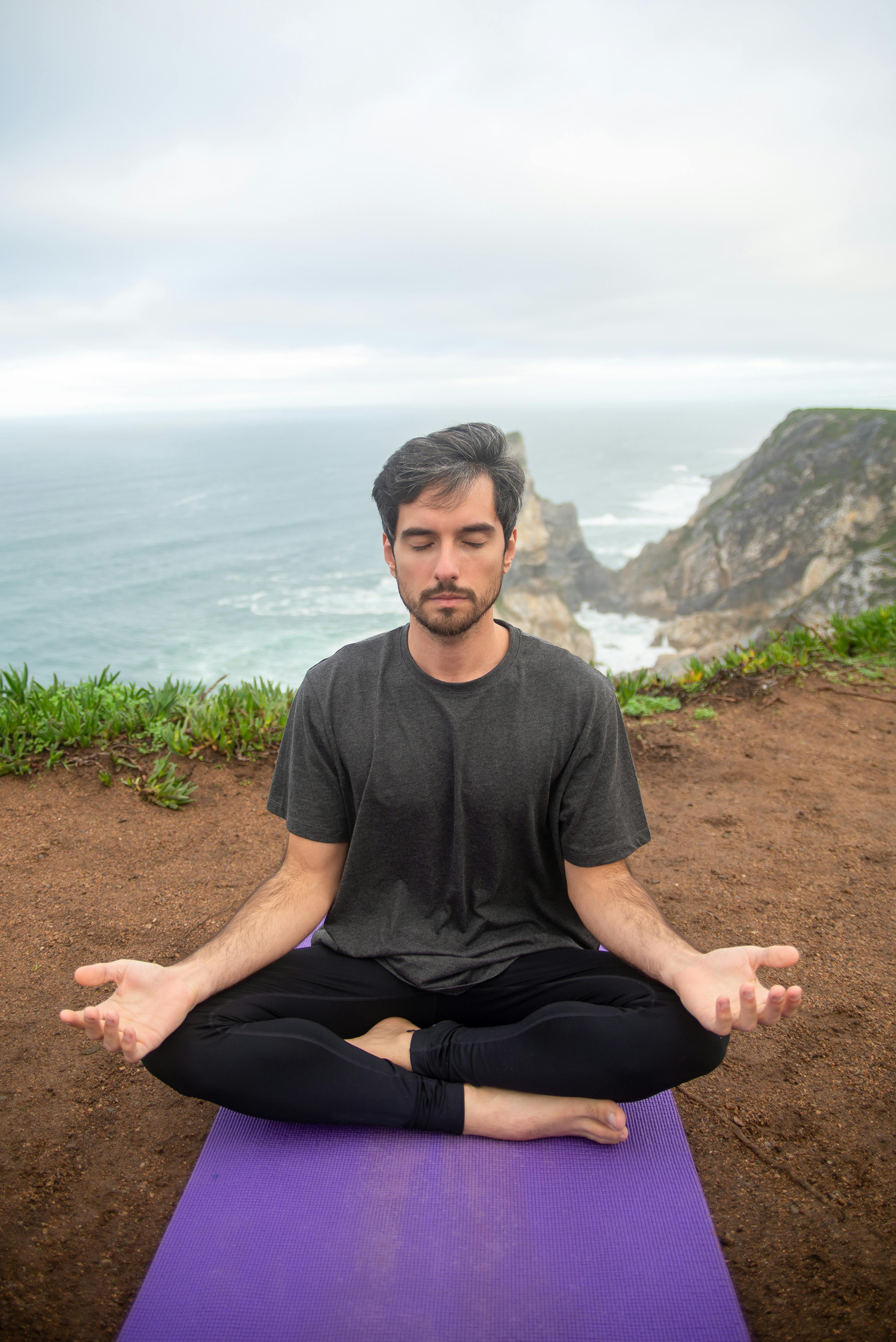 Man Meditating near Cliff · Free Stock Photo