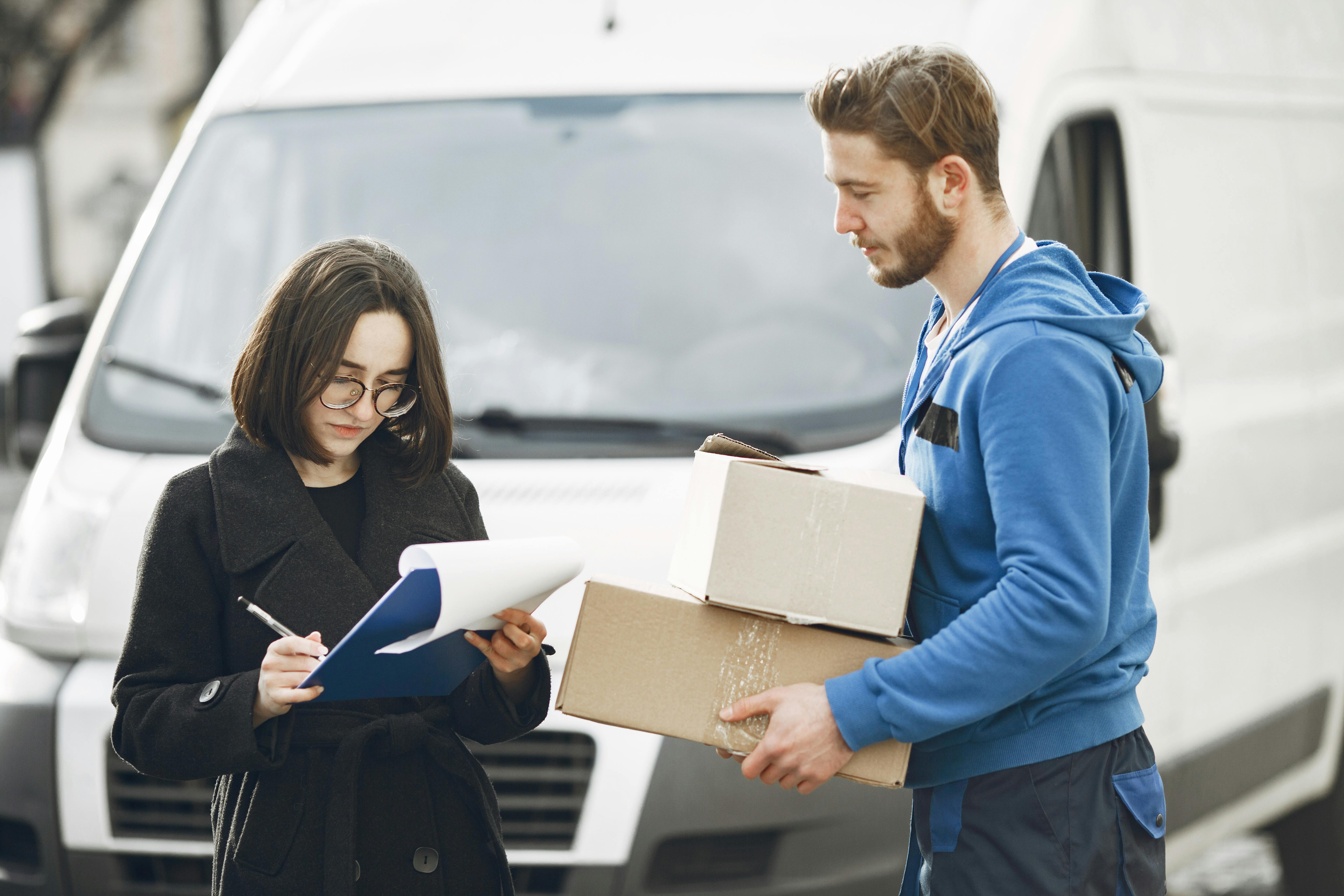 Man Delivering Packages to Woman · Free Stock Photo