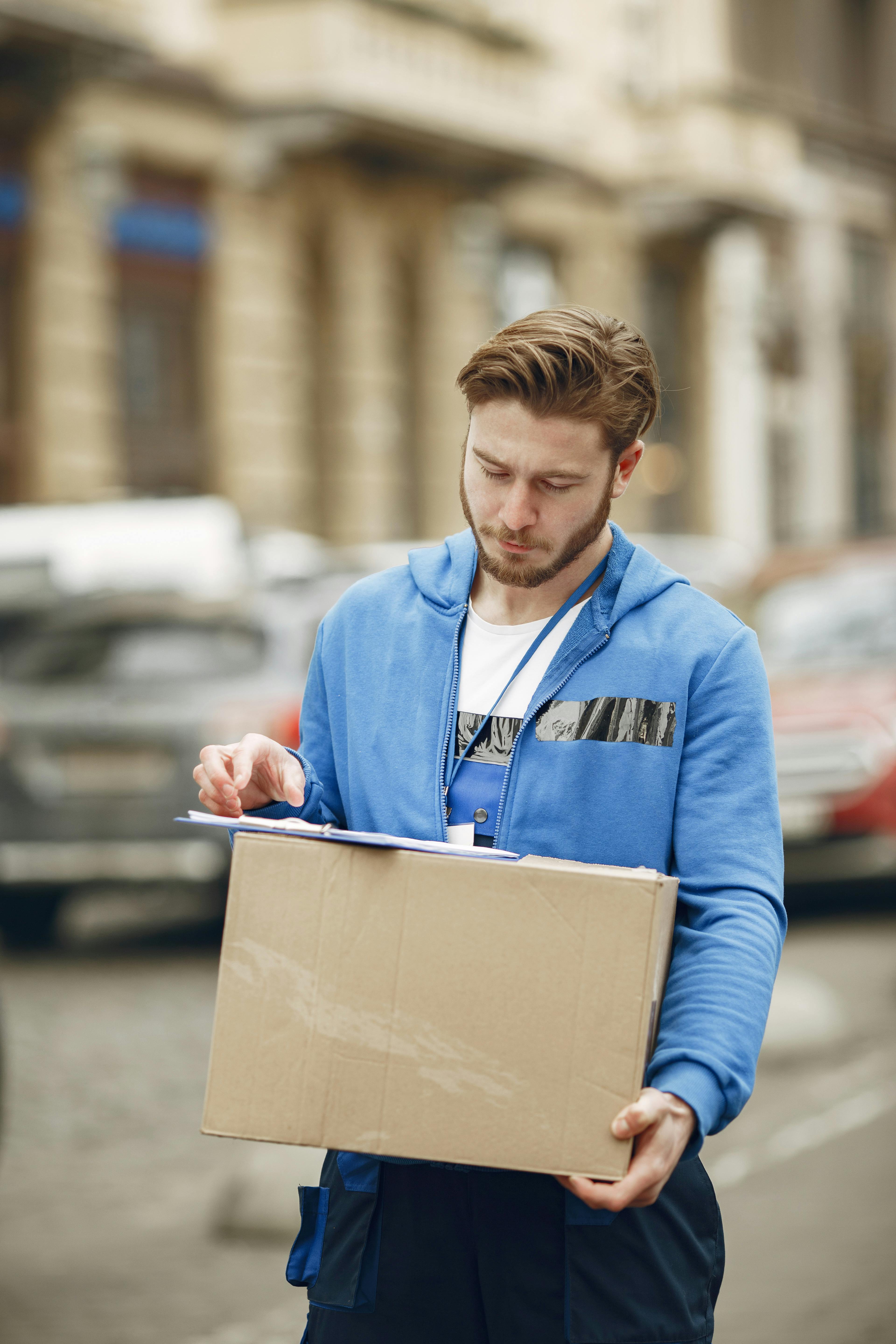 Courier with Package on Street · Free Stock Photo