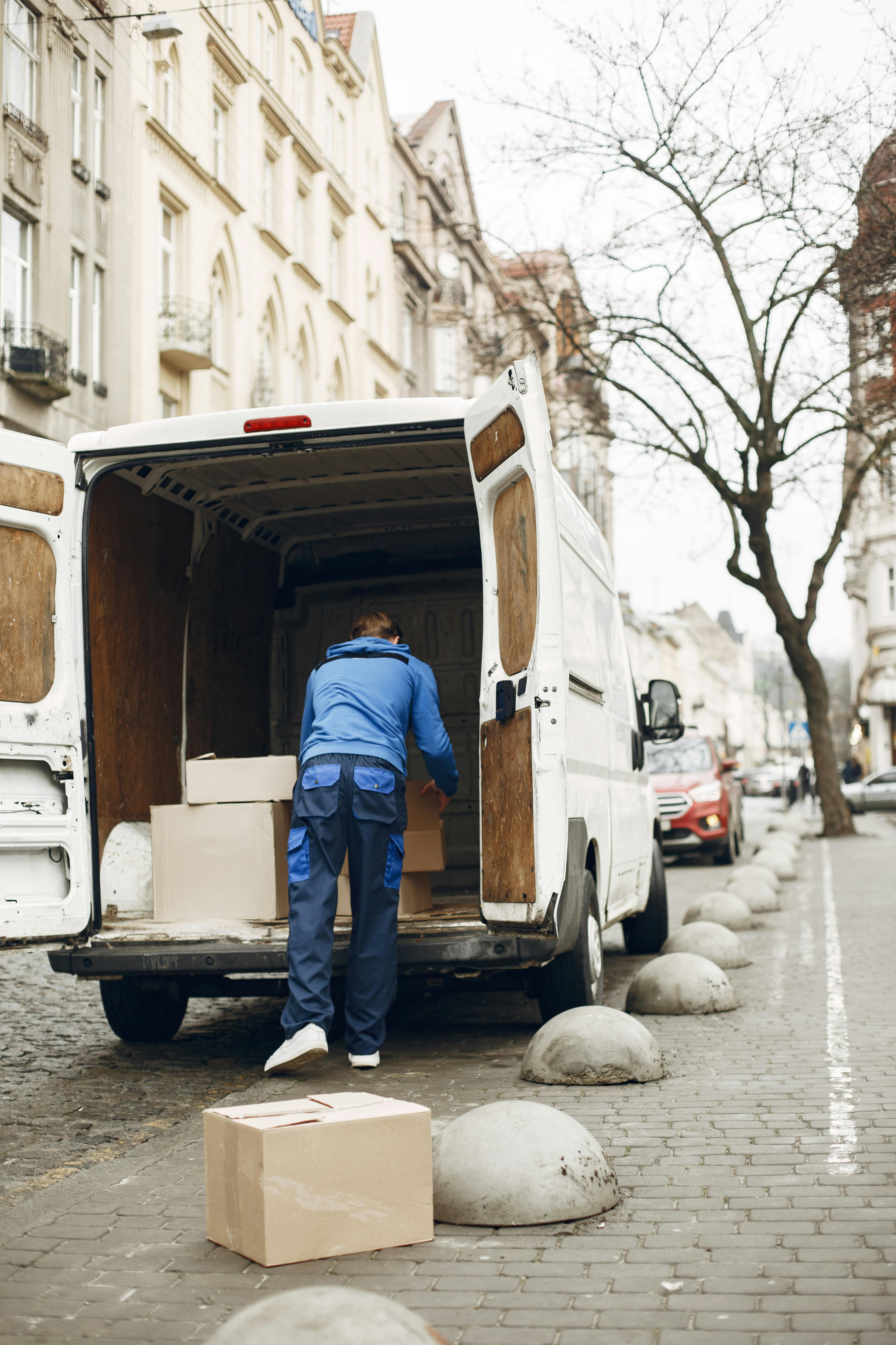 Man Packing Boxes into a Truck · Free Stock Photo
