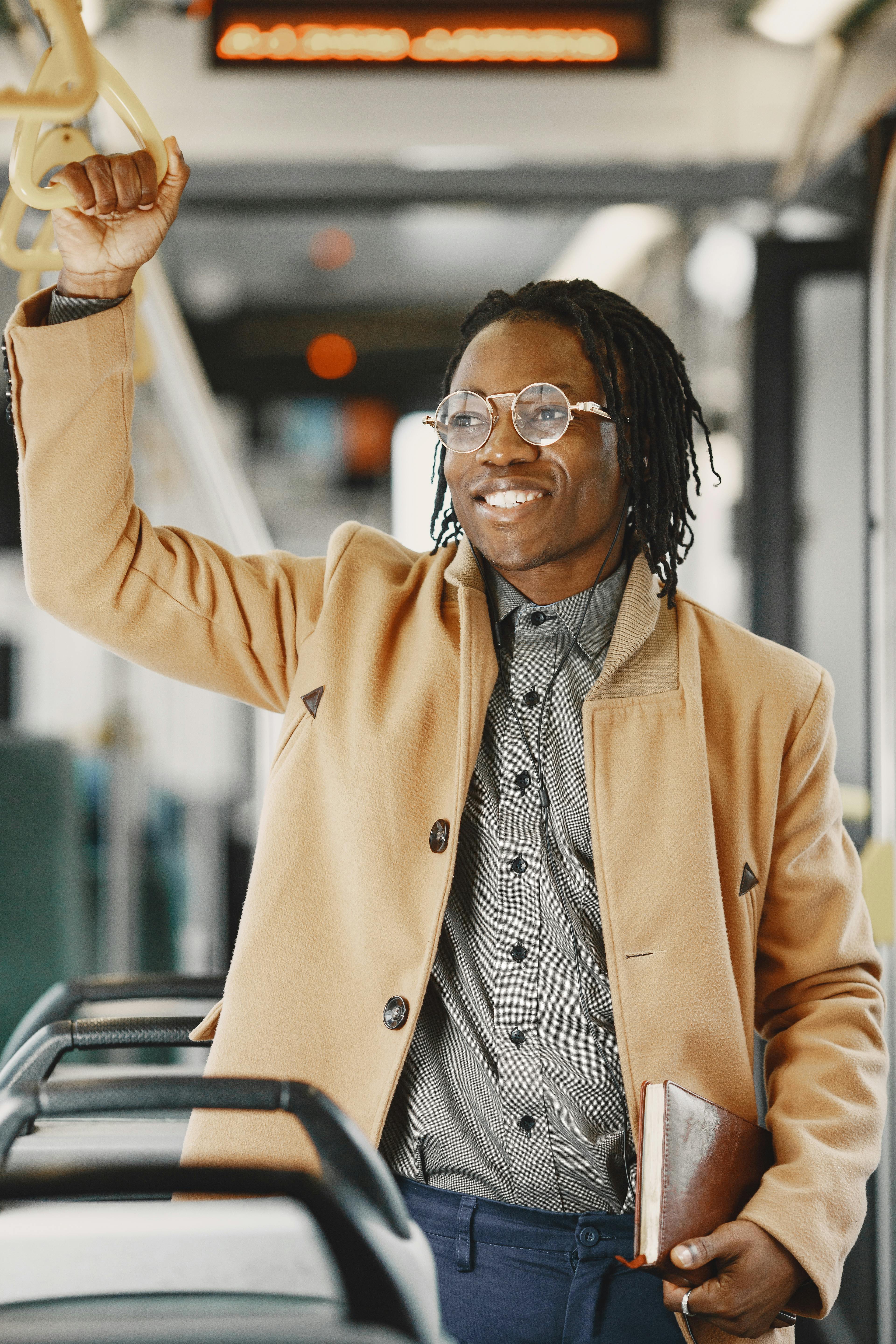 Portrait of Man Standing in Bus Smiling · Free Stock Photo