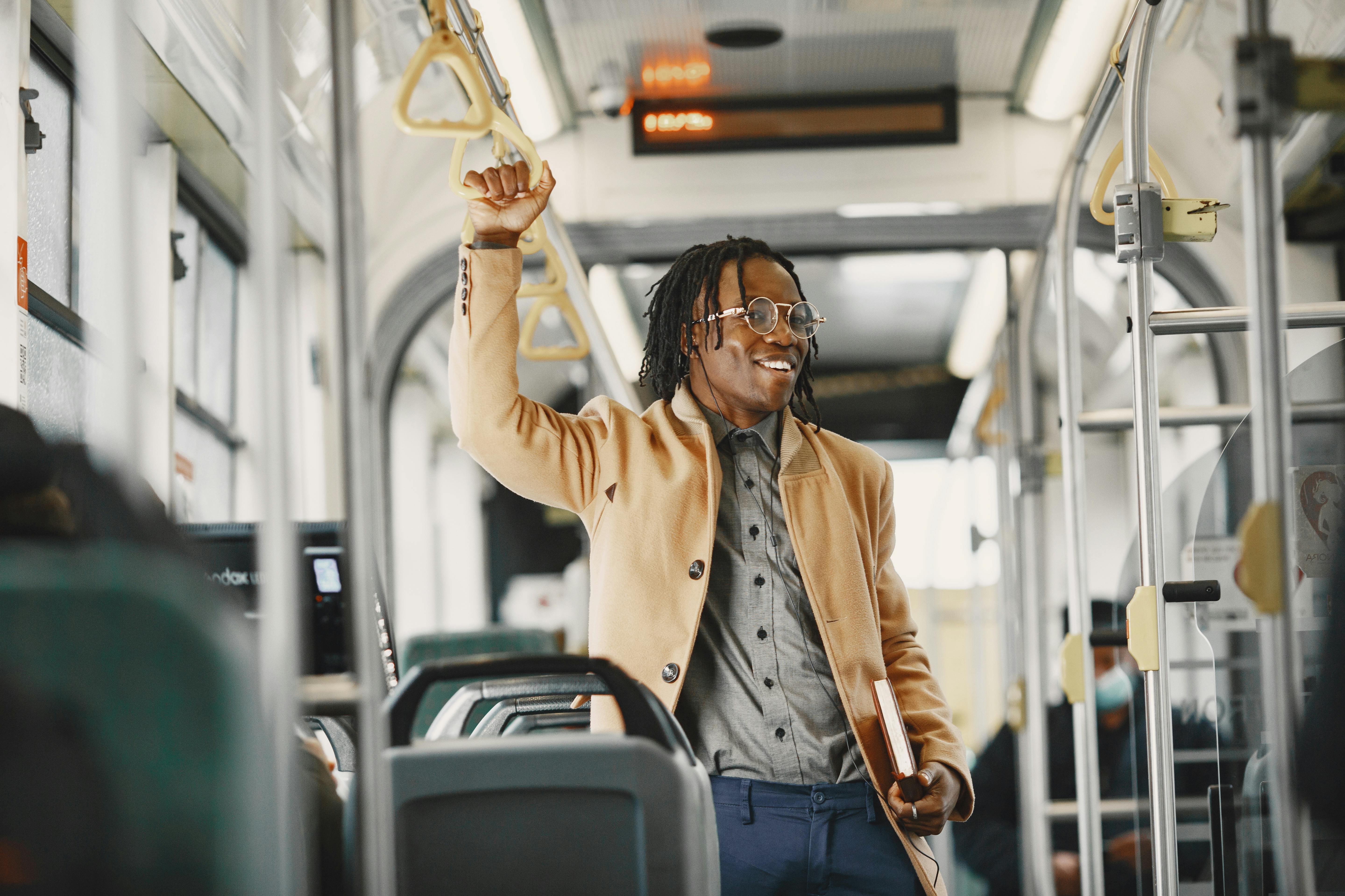 Smiling Man in Public Transport · Free Stock Photo