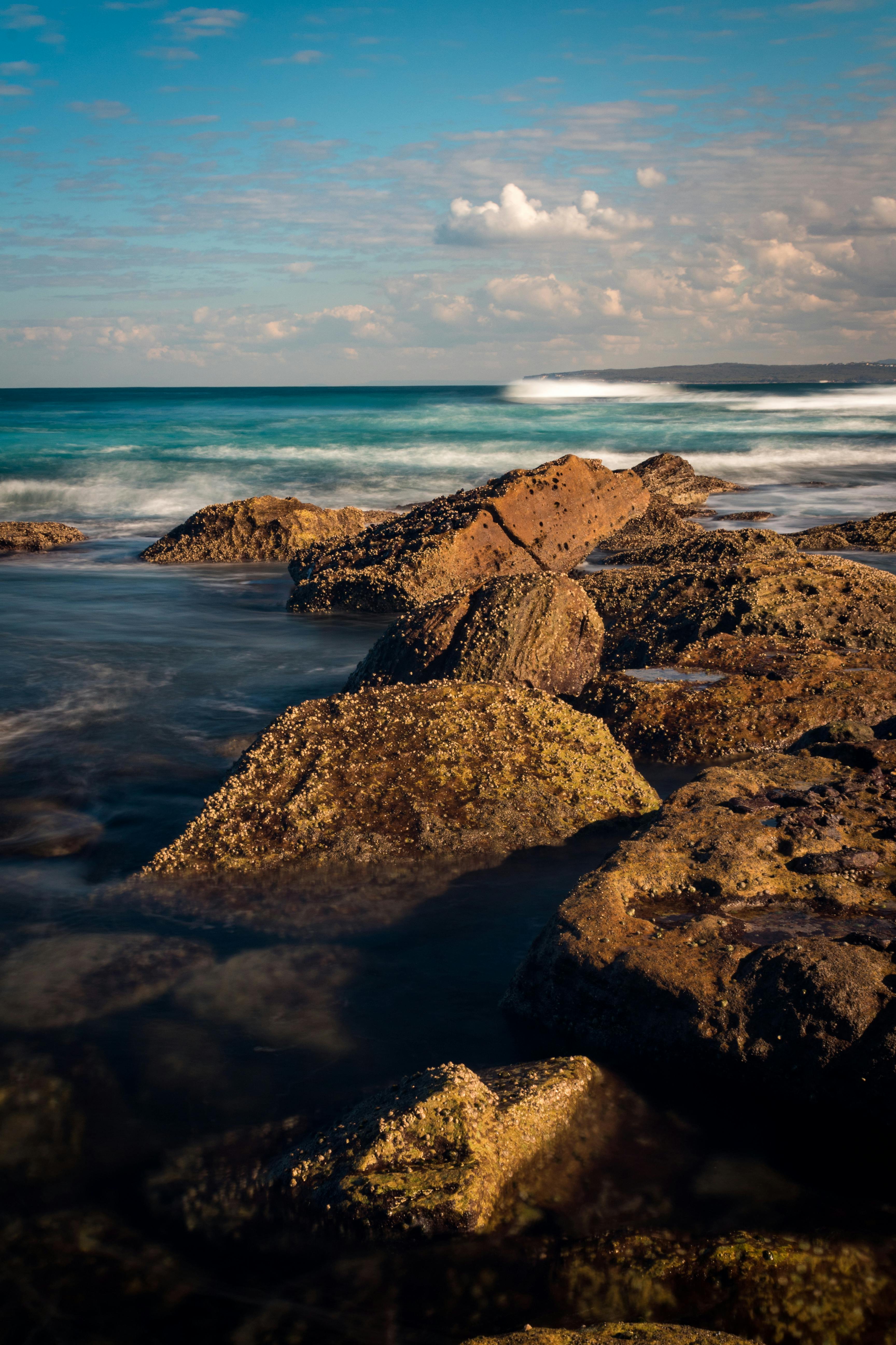 A Rocky Shore during Sunset · Free Stock Photo