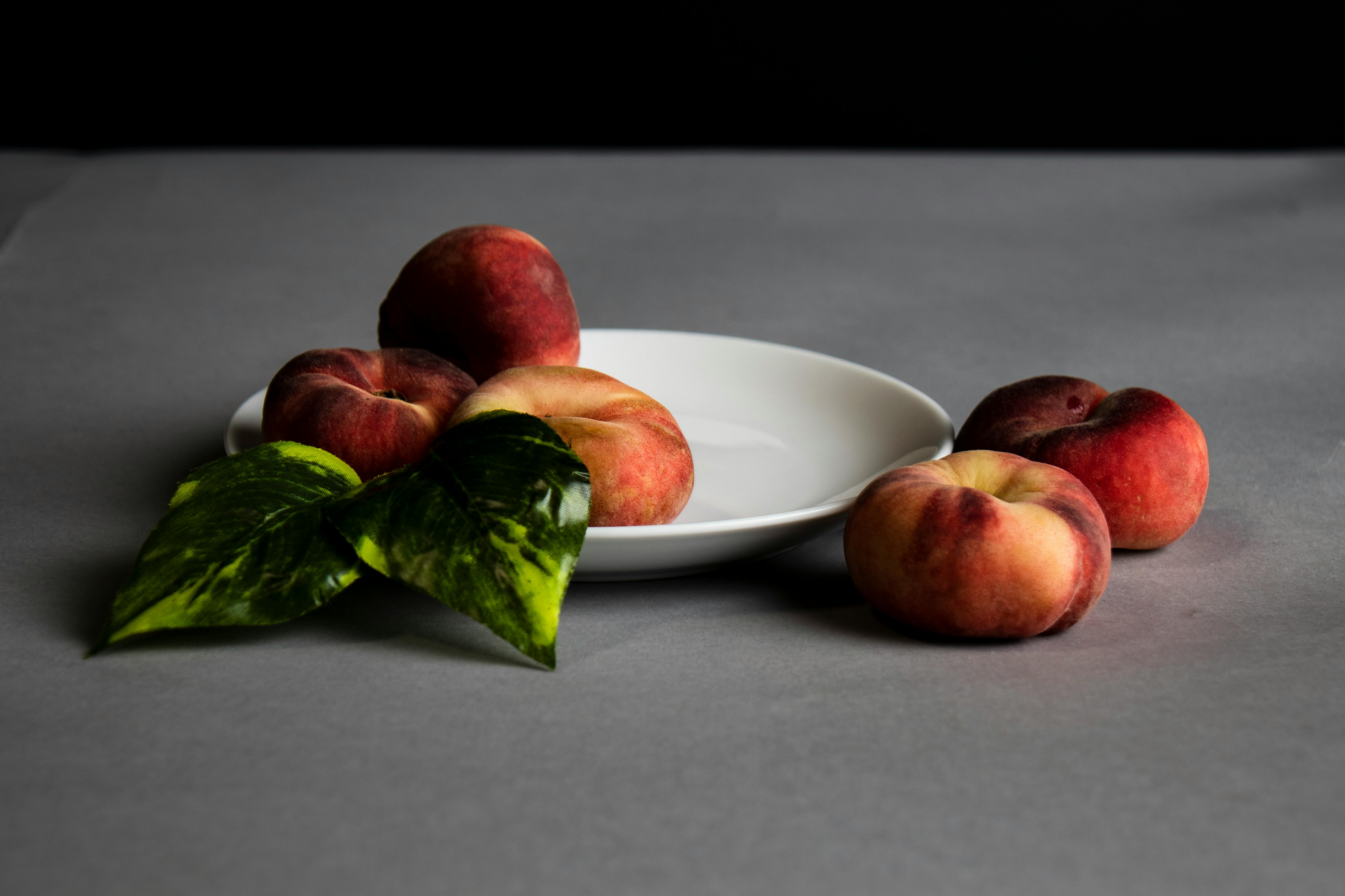 A Close-Up Shot of a Peach on a Book · Free Stock Photo