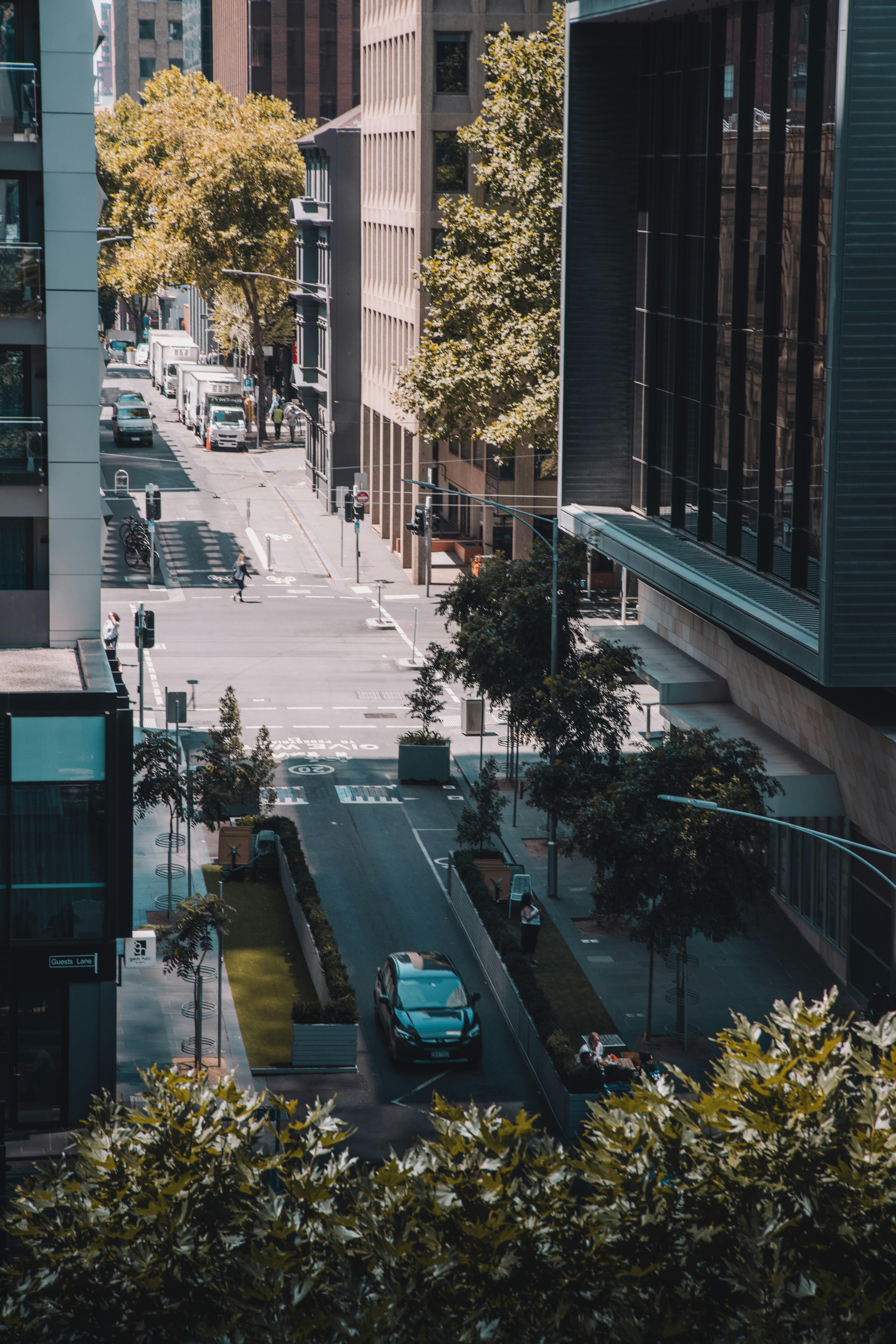 High-Angle Shot of a Car Driving on the Street · Free Stock Photo