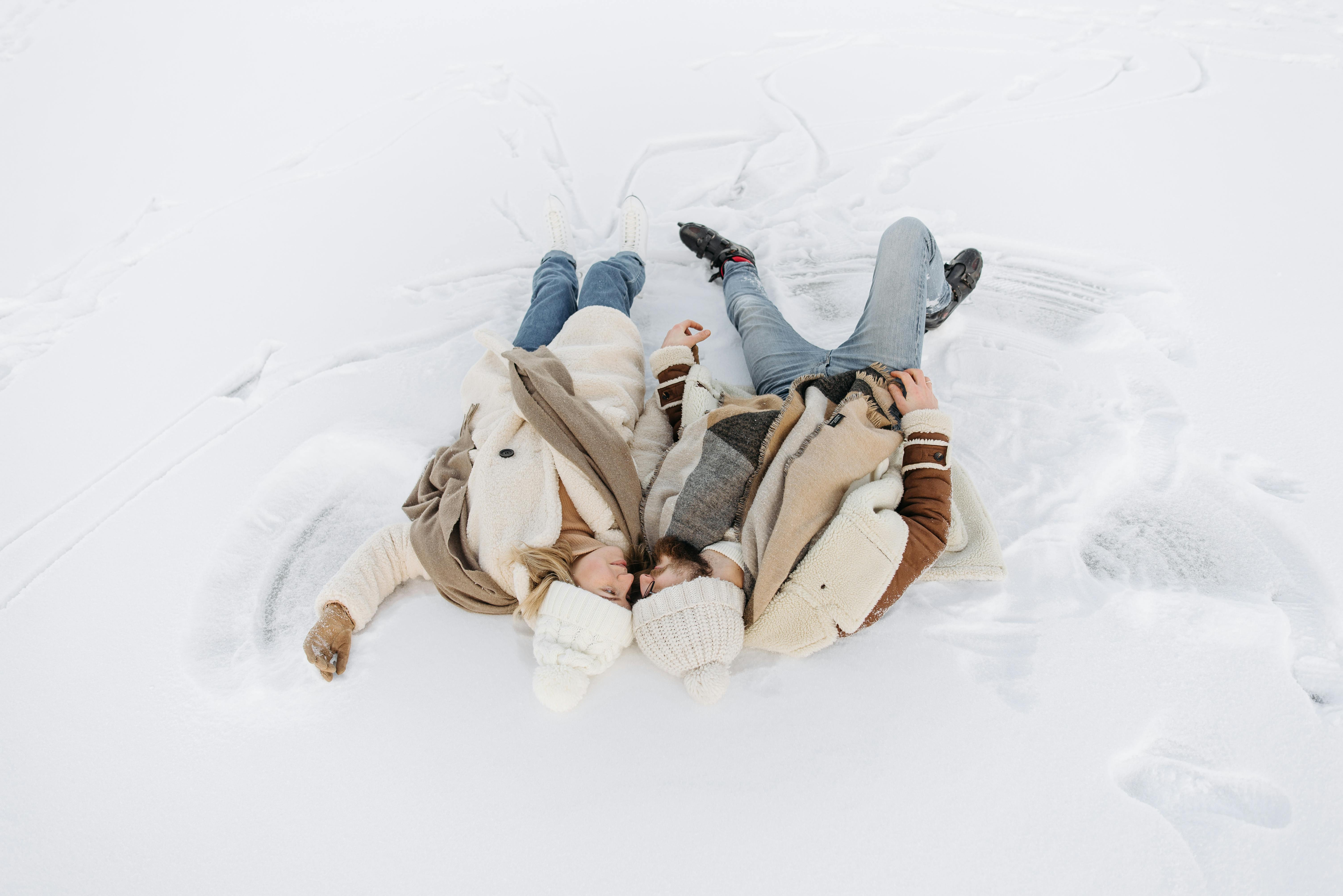 Couple Lying Down on the Snow · Free Stock Photo