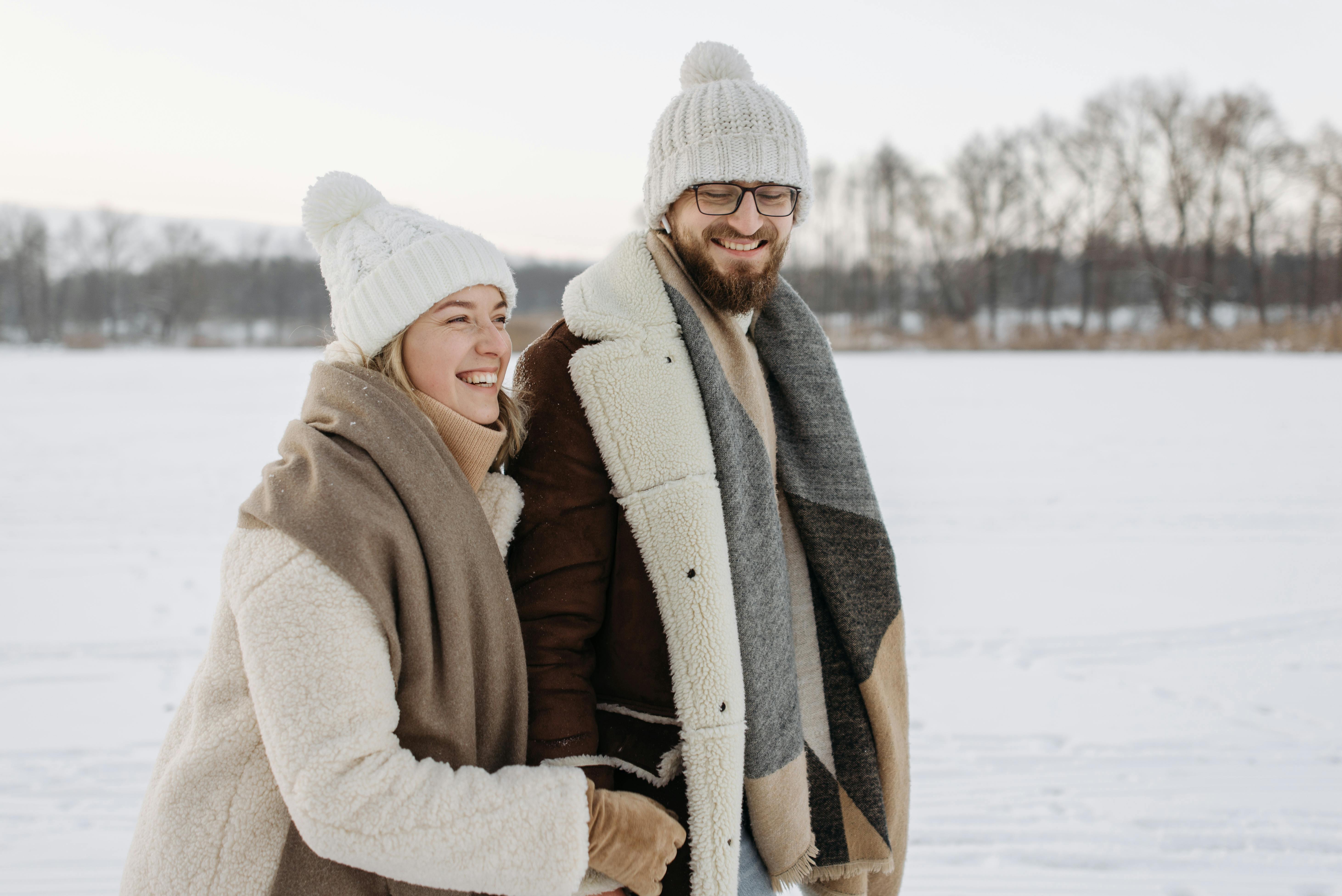 Close-Up Shot of a Couple Wearing Winter Clothes Smiling Together ...