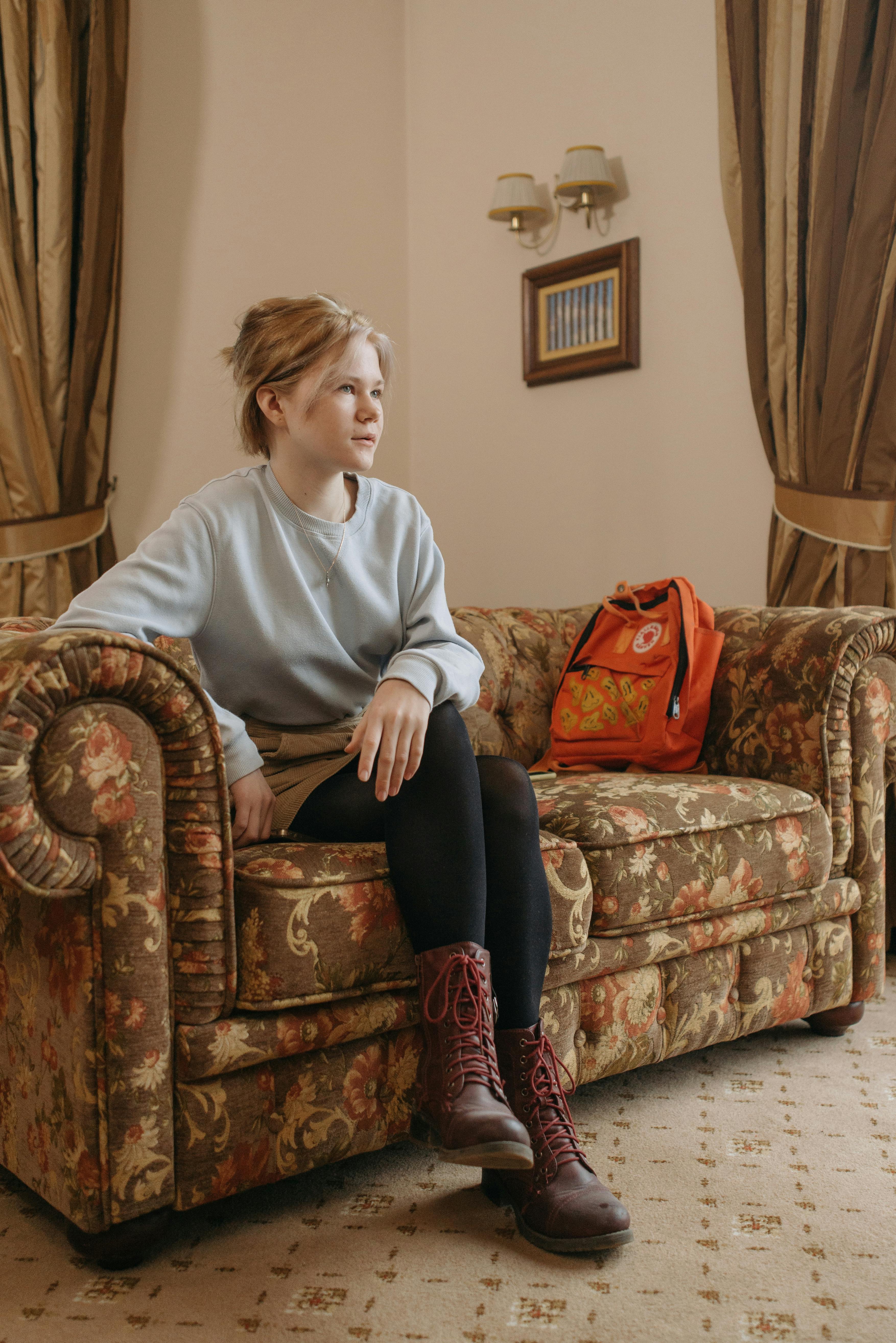 Girl Sitting on Green Couch while Wearing White Tights · Free Stock Photo