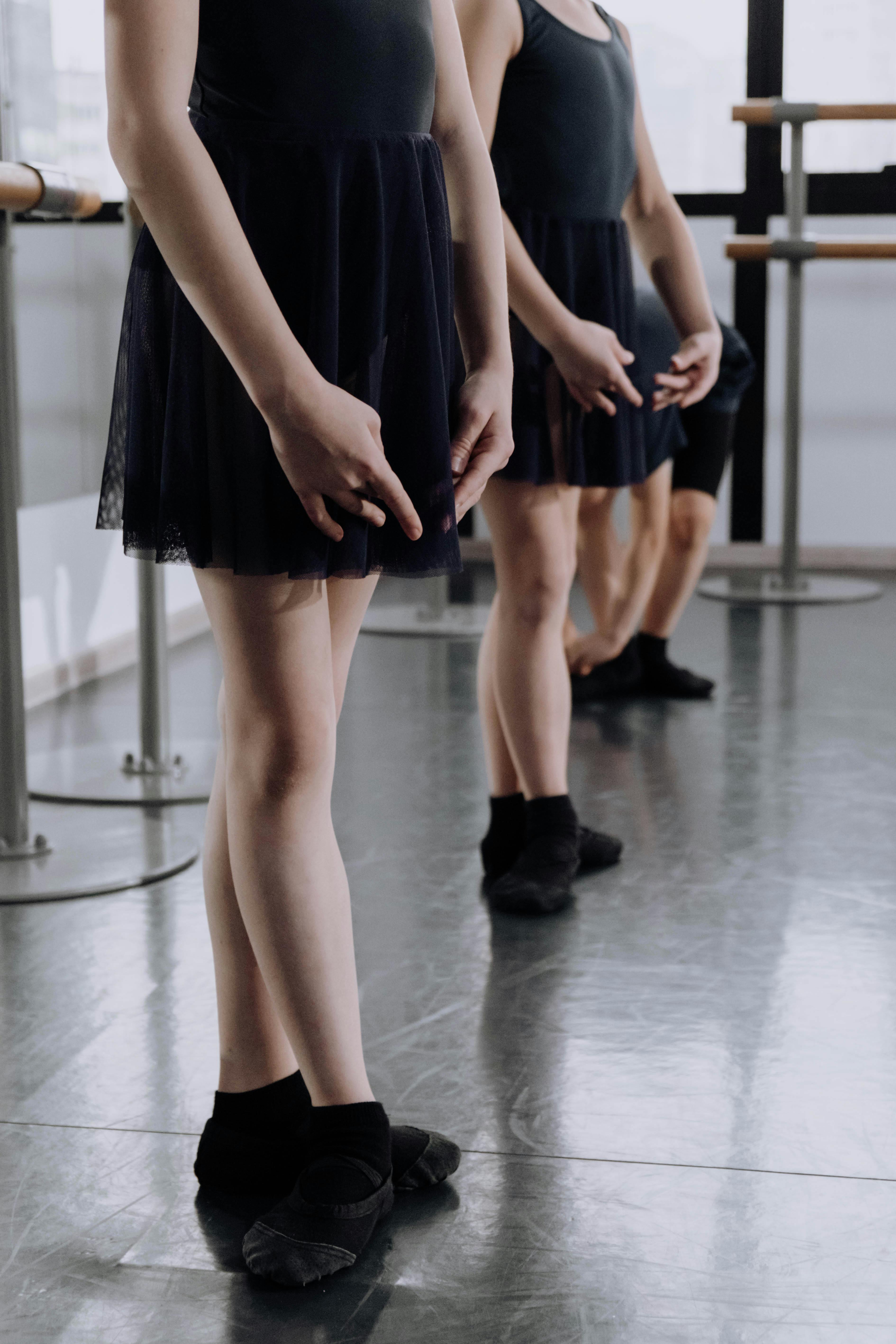 Two Ballerinas Doing Ballet Moves Beside Ballet Bar · Free Stock Photo