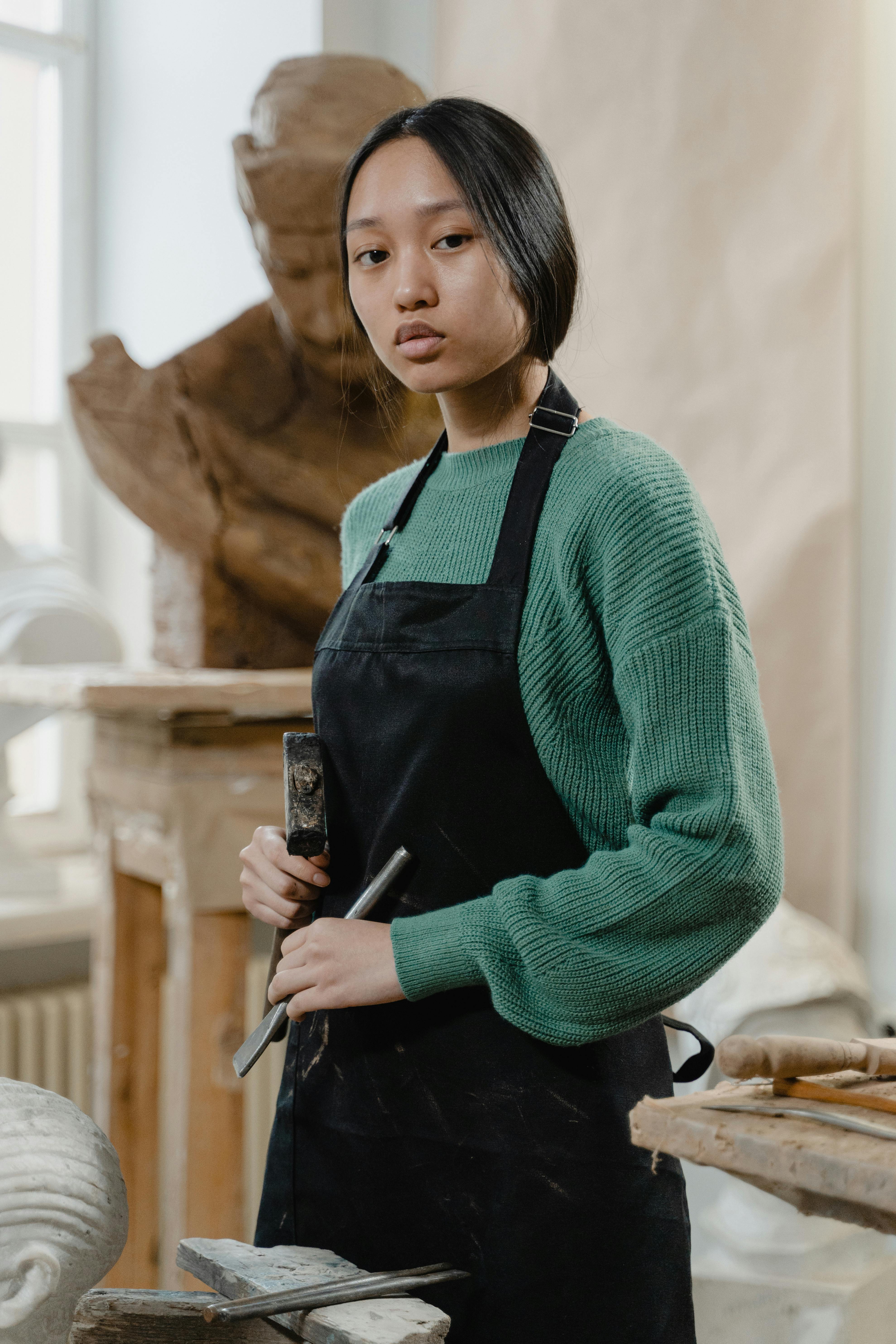 A Person Using a Hammer and a Chisel · Free Stock Photo